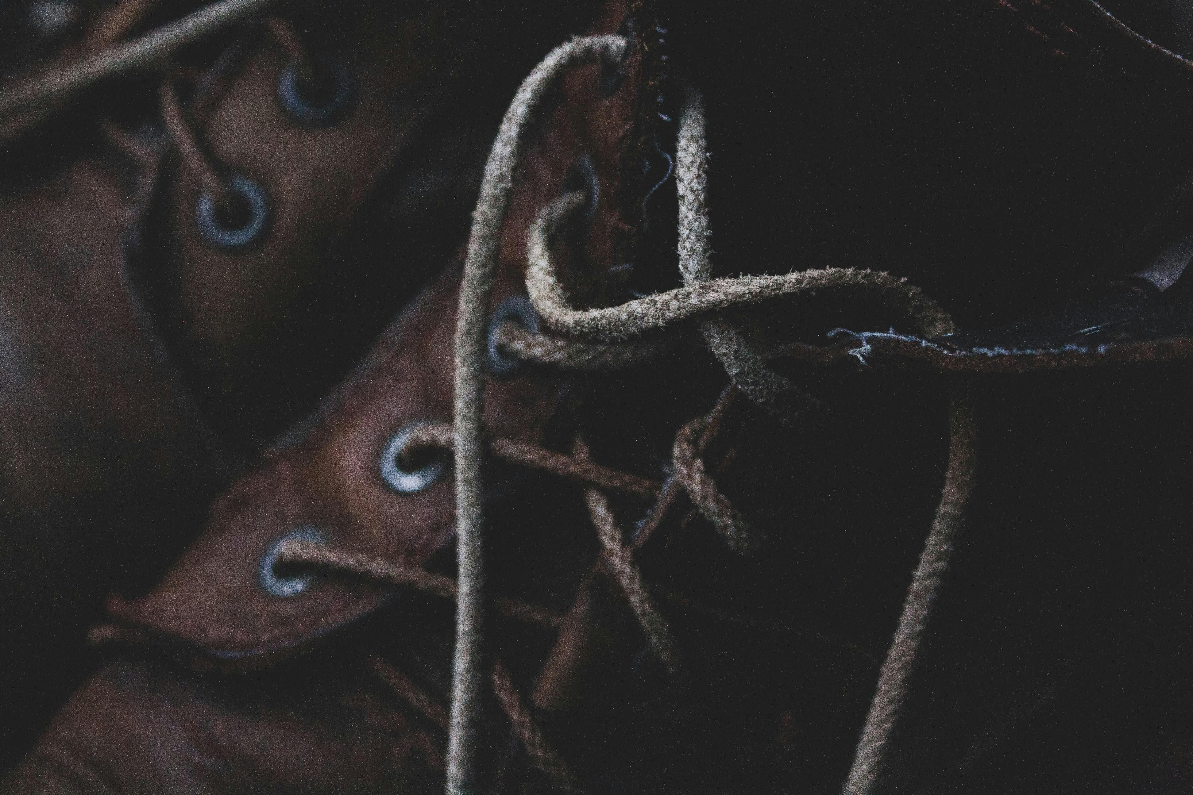 Close-up of brown leather boots with laces intertwined, showcasing wear and character.