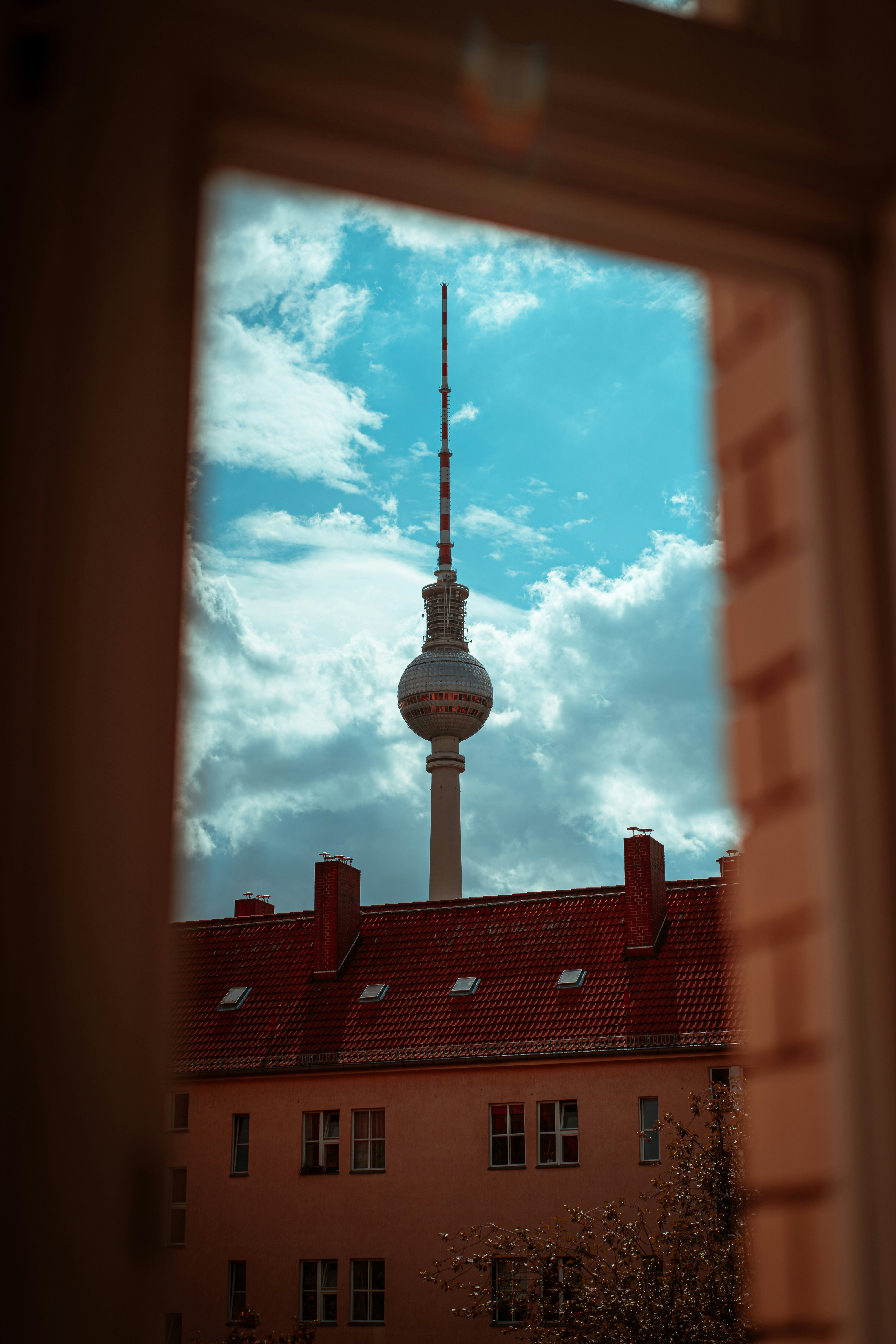 The tower of berlin from the bathroom window at the hostel | brown concrete building under blue sky during daytime