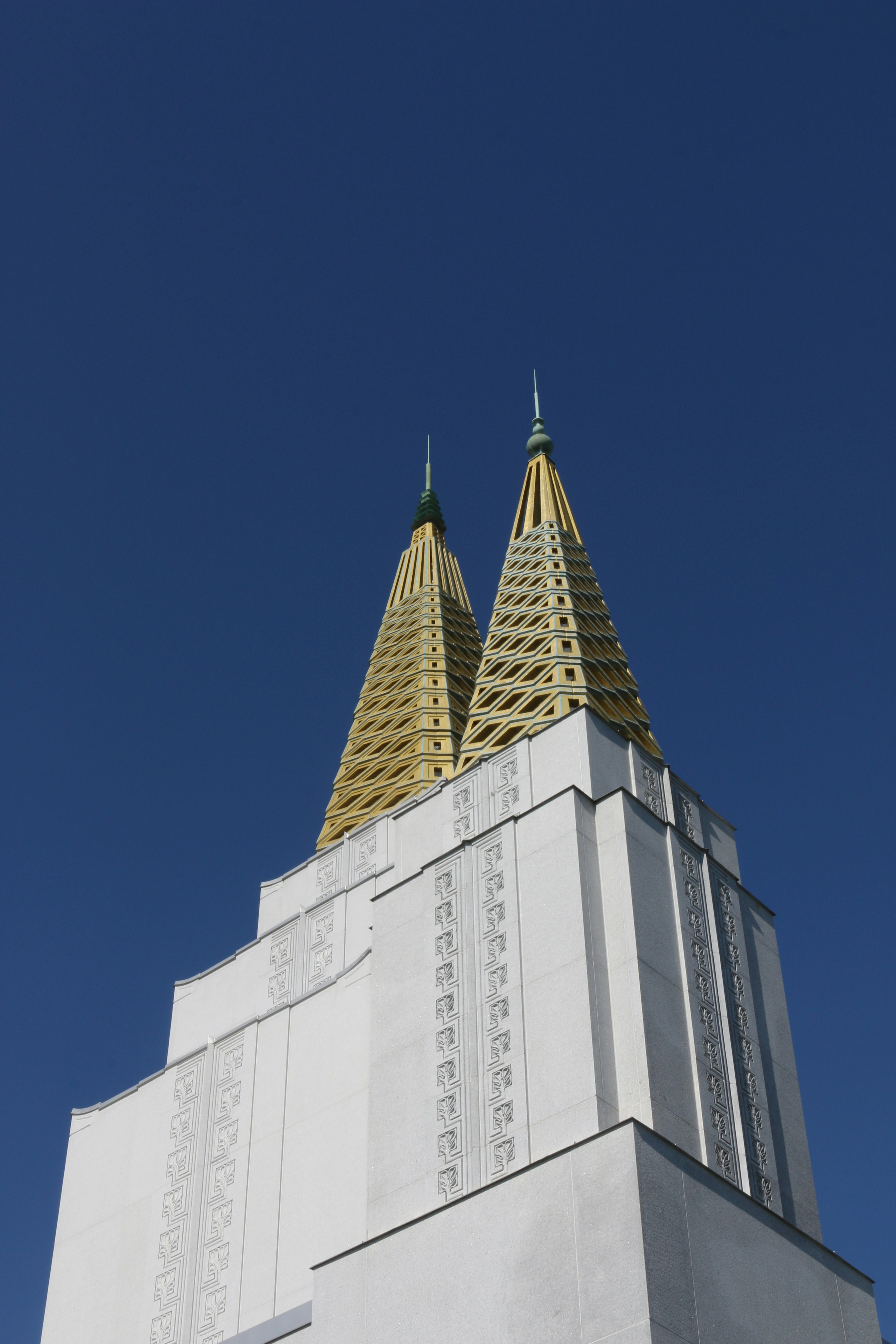 Distinctive twin spires adorned with intricate patterns against a clear blue sky.
