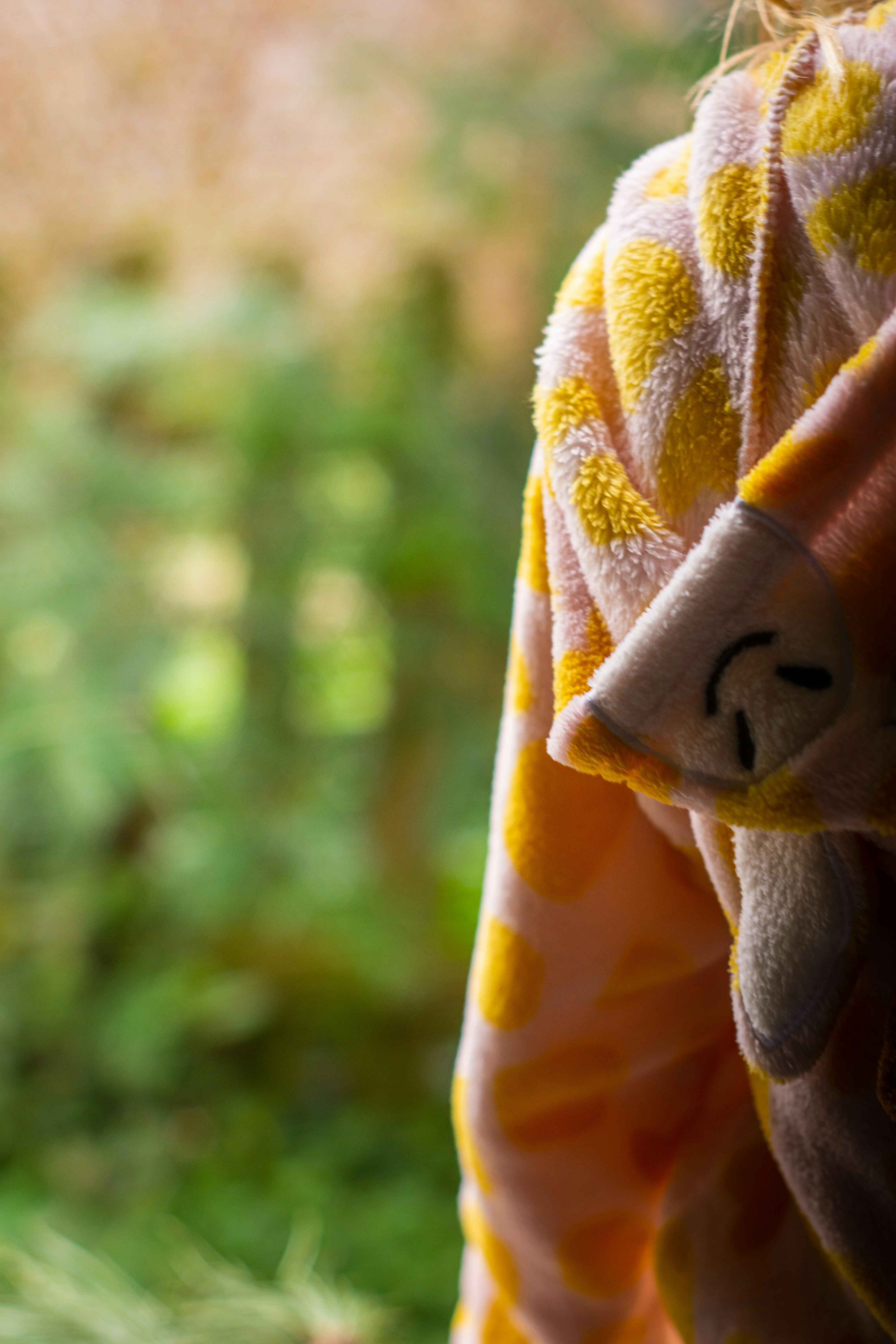 Cozy Blanket Portrait: Soft Dolds of Yellow and Plush Texture