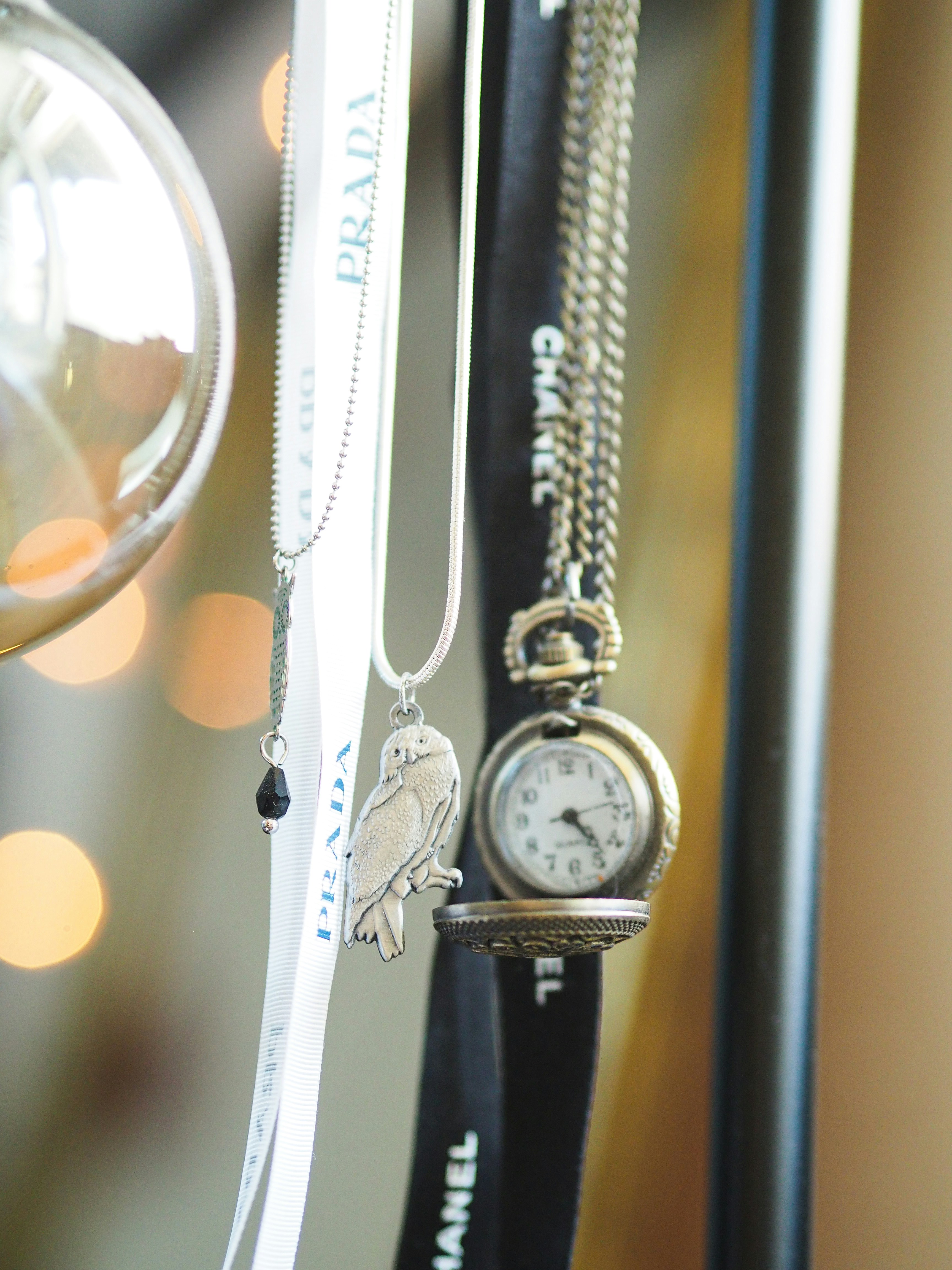 Ticking Elegance: A Pocket Watch Among Delicate Pendants