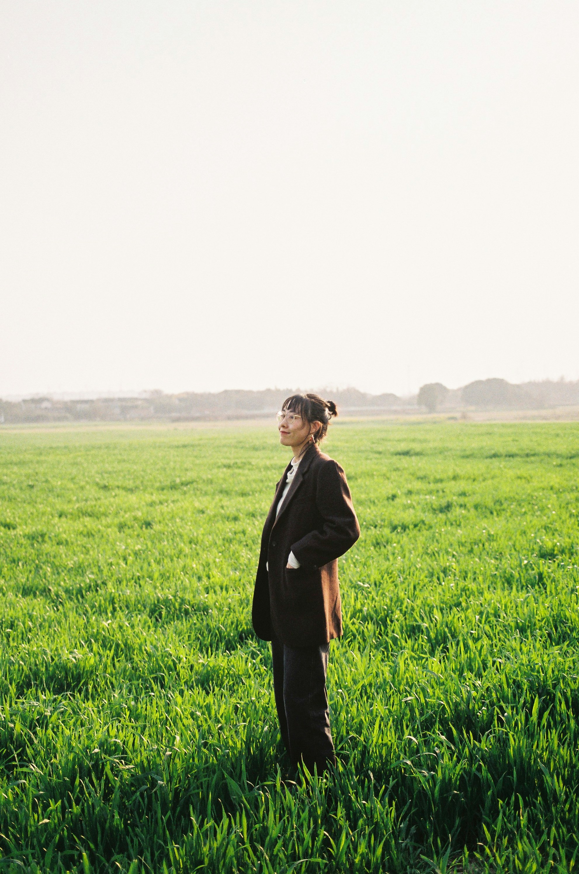 woman in black long sleeve shirt standing on green grass field during daytime