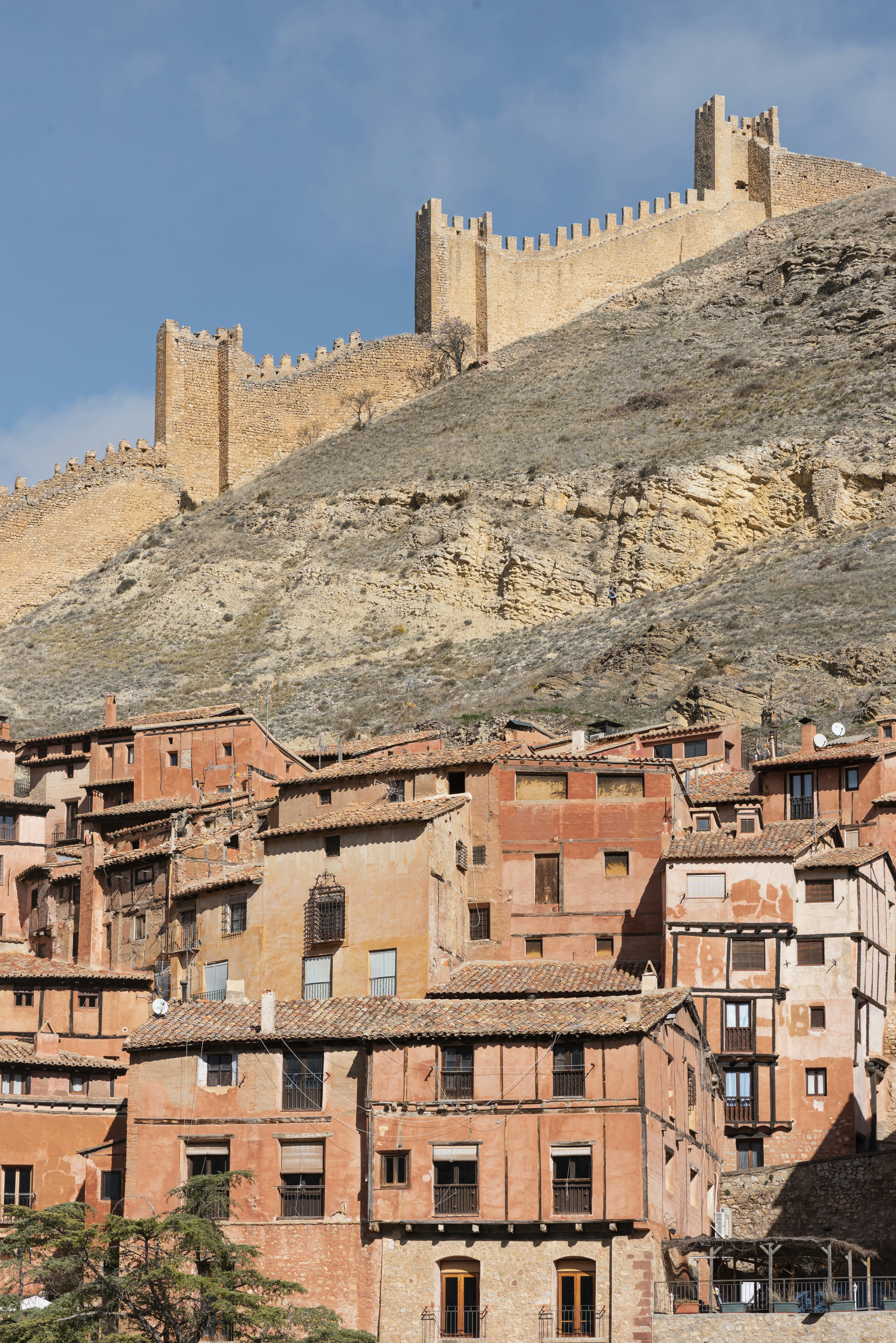Brown concrete building near mountain during daytime photo – Free Blue ...