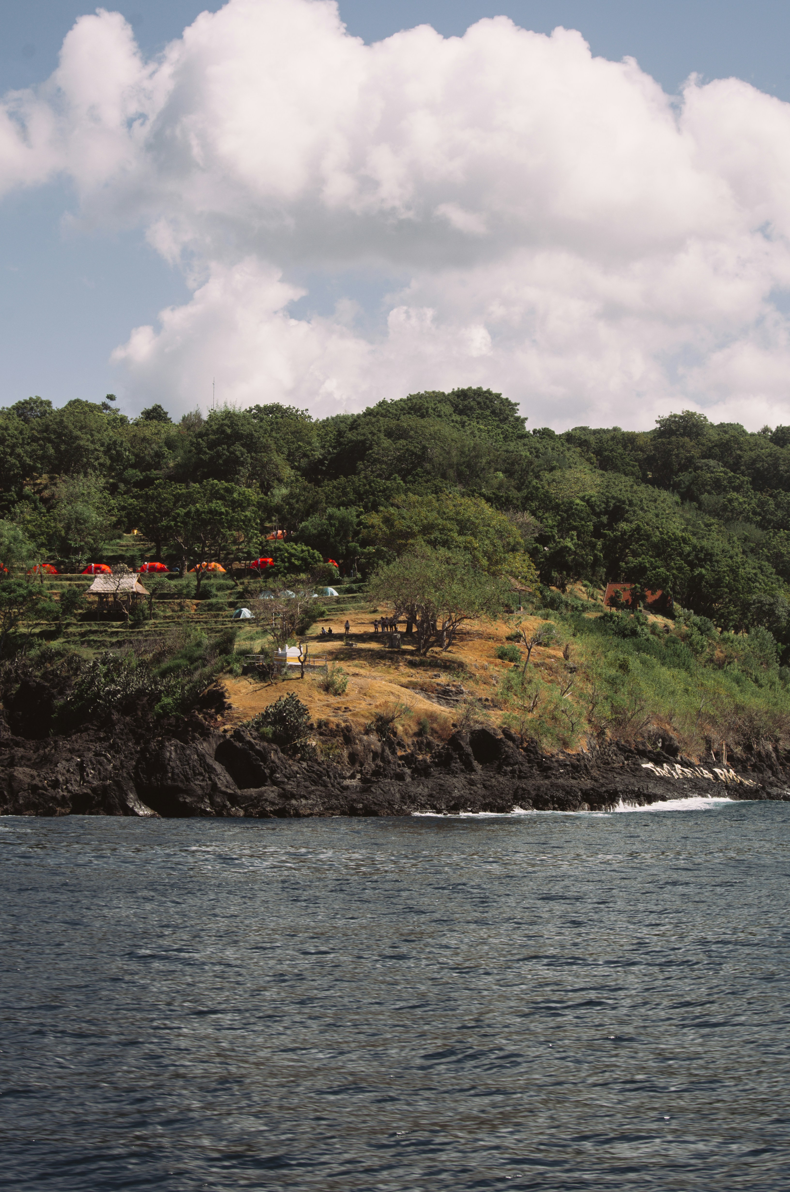 Red Umbrellas Crown a Clifftop Terrace by the Sea
