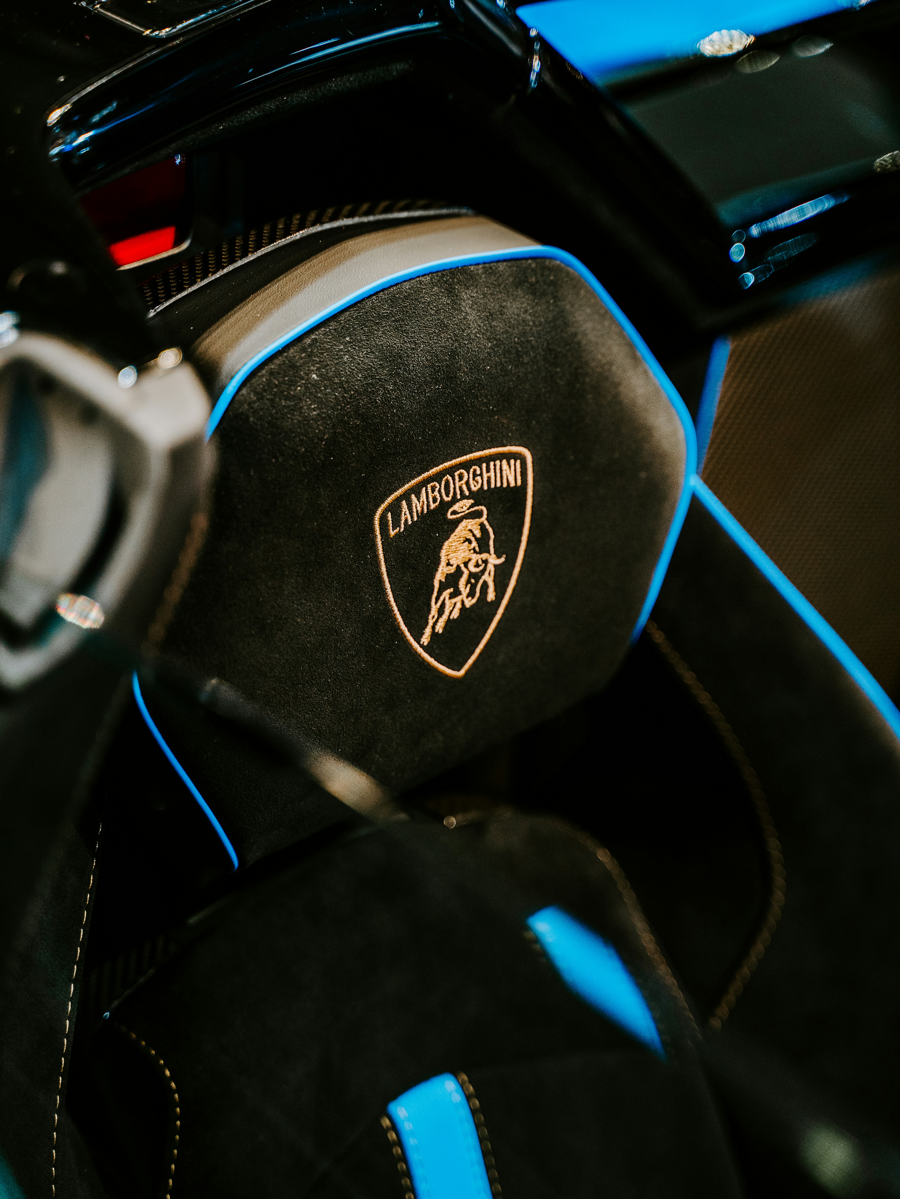 Lamborghini Crest in Close-Up: Hand-stitched Luxury and Blue Accents