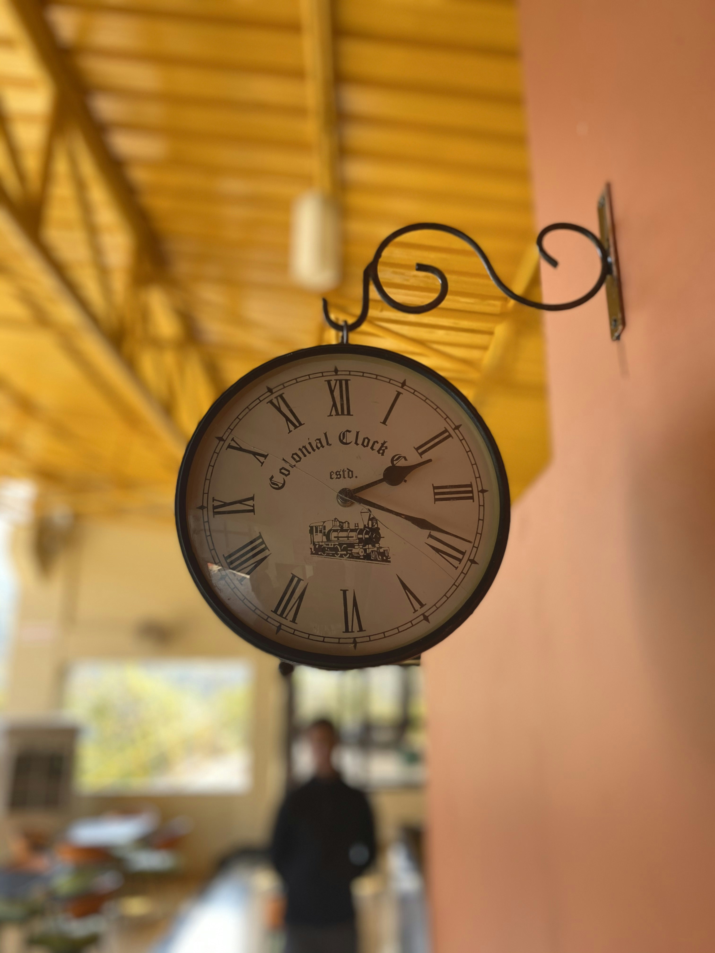 Time Framed by Iron Curves in a Sunlit Café