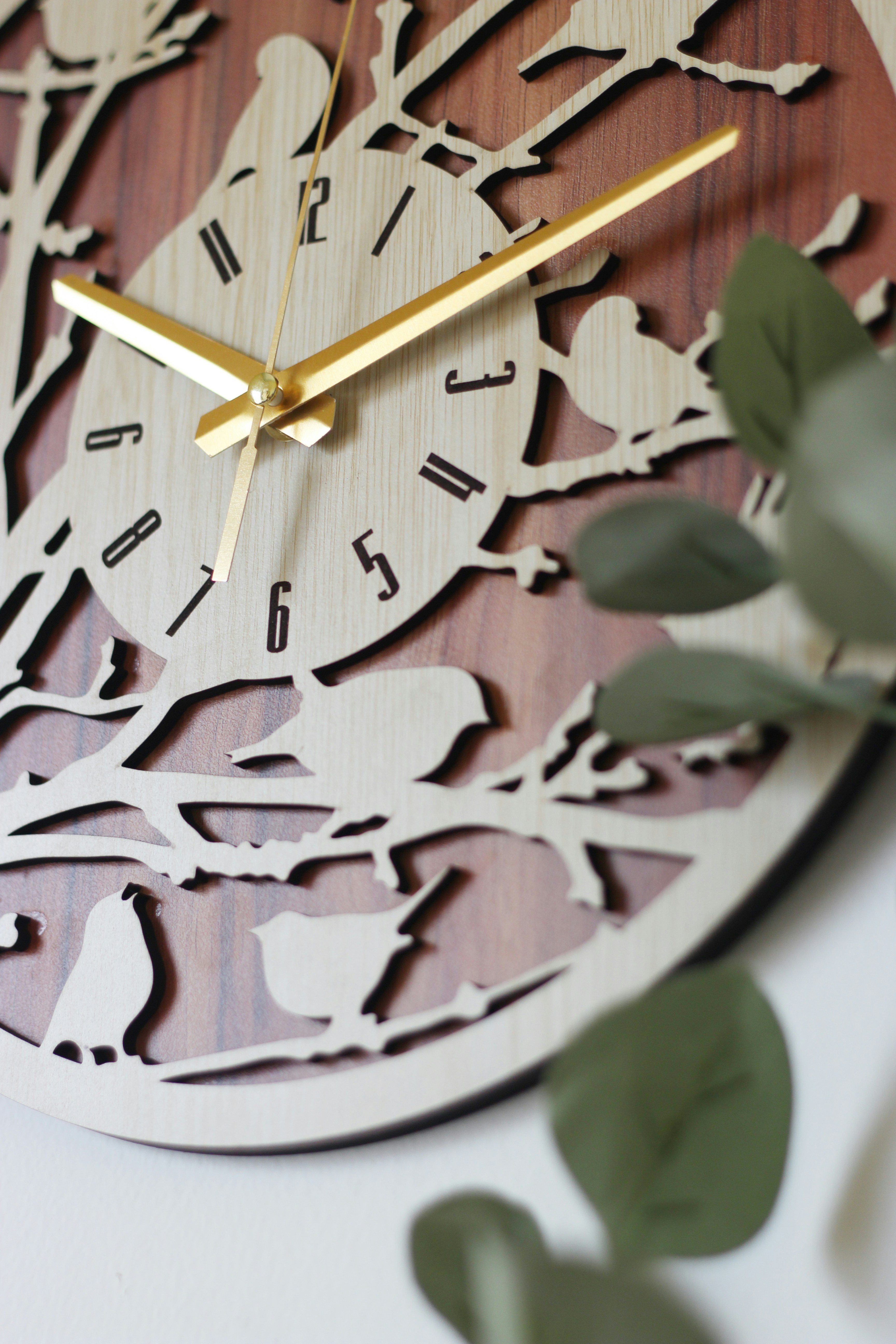Golden Hands on a Wooden Lattice Clock Framed by Soft Greenery