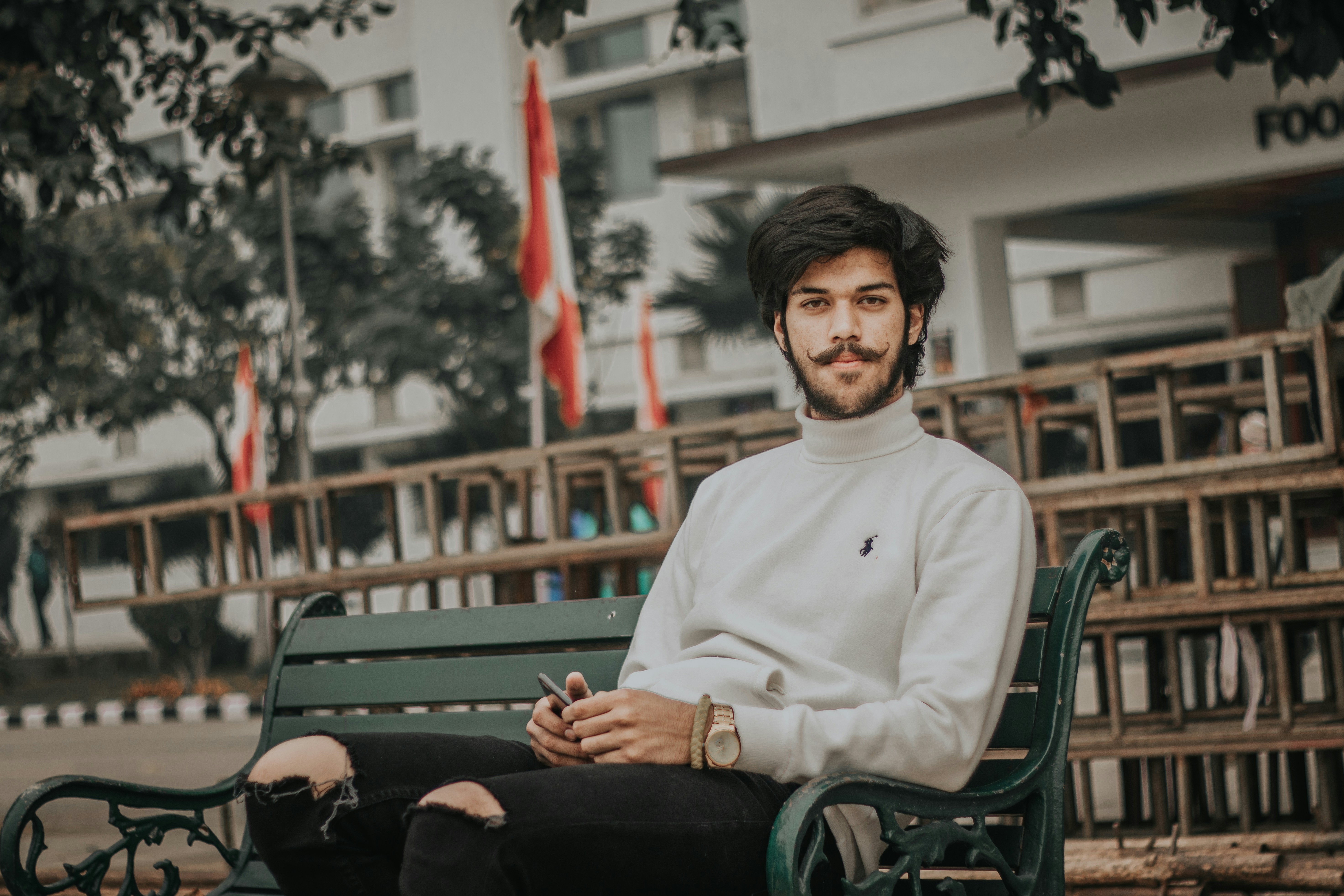 Man in white sweater sitting on green bench during daytime photo – Free ...