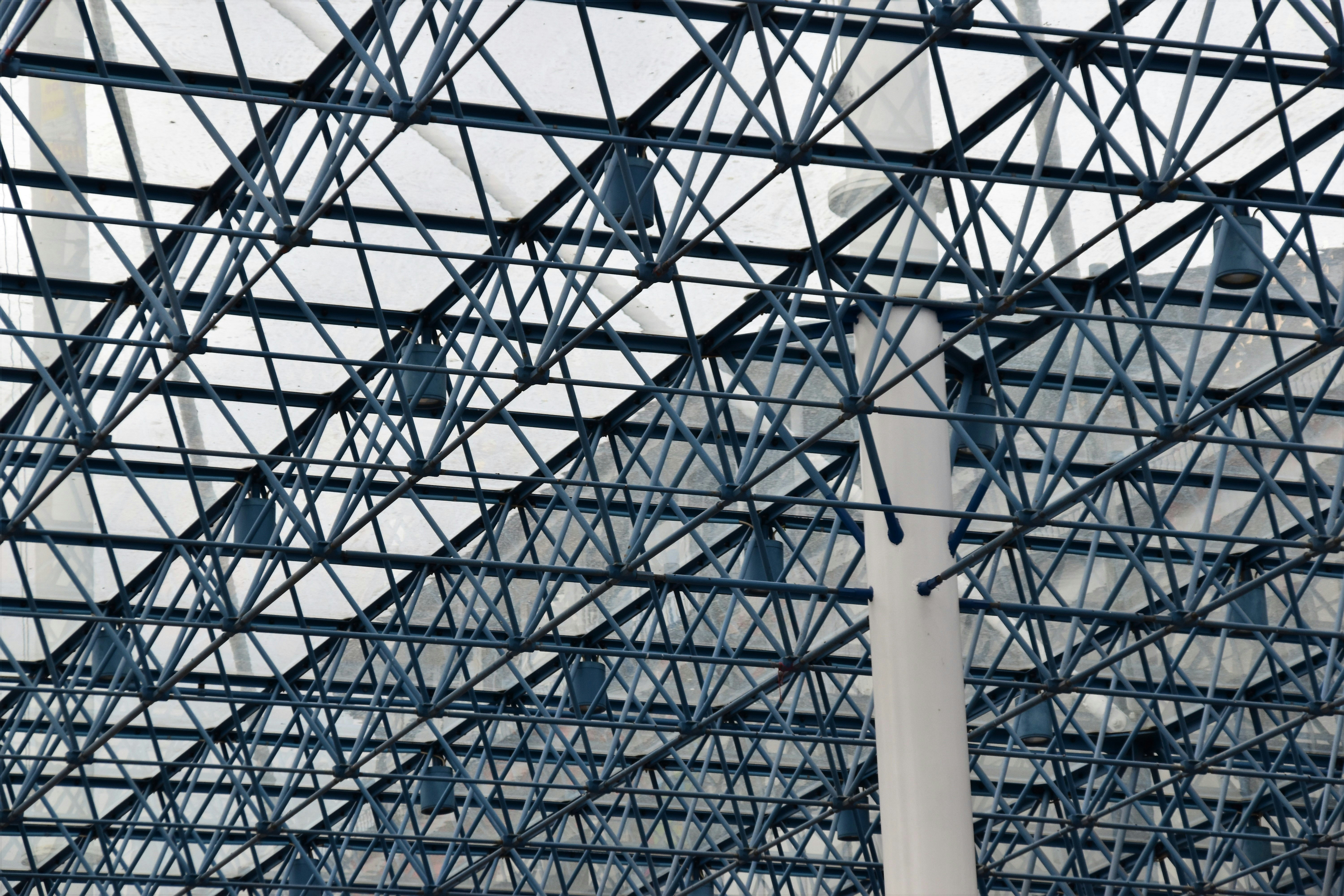 Interwoven Canopy: blue steel lattice tracing a cathedral of light