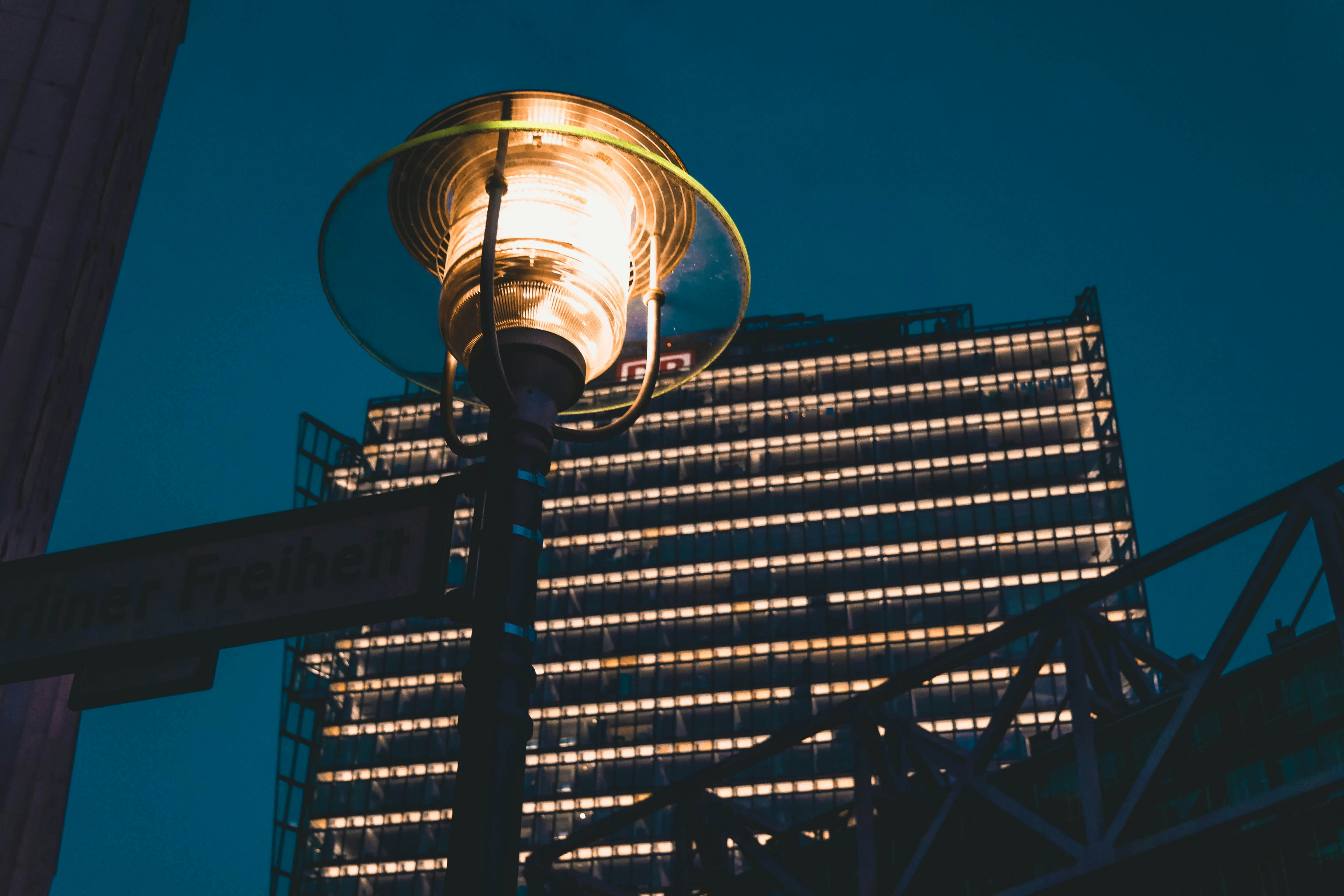 Nightlit Lantern Over a Modern Facade