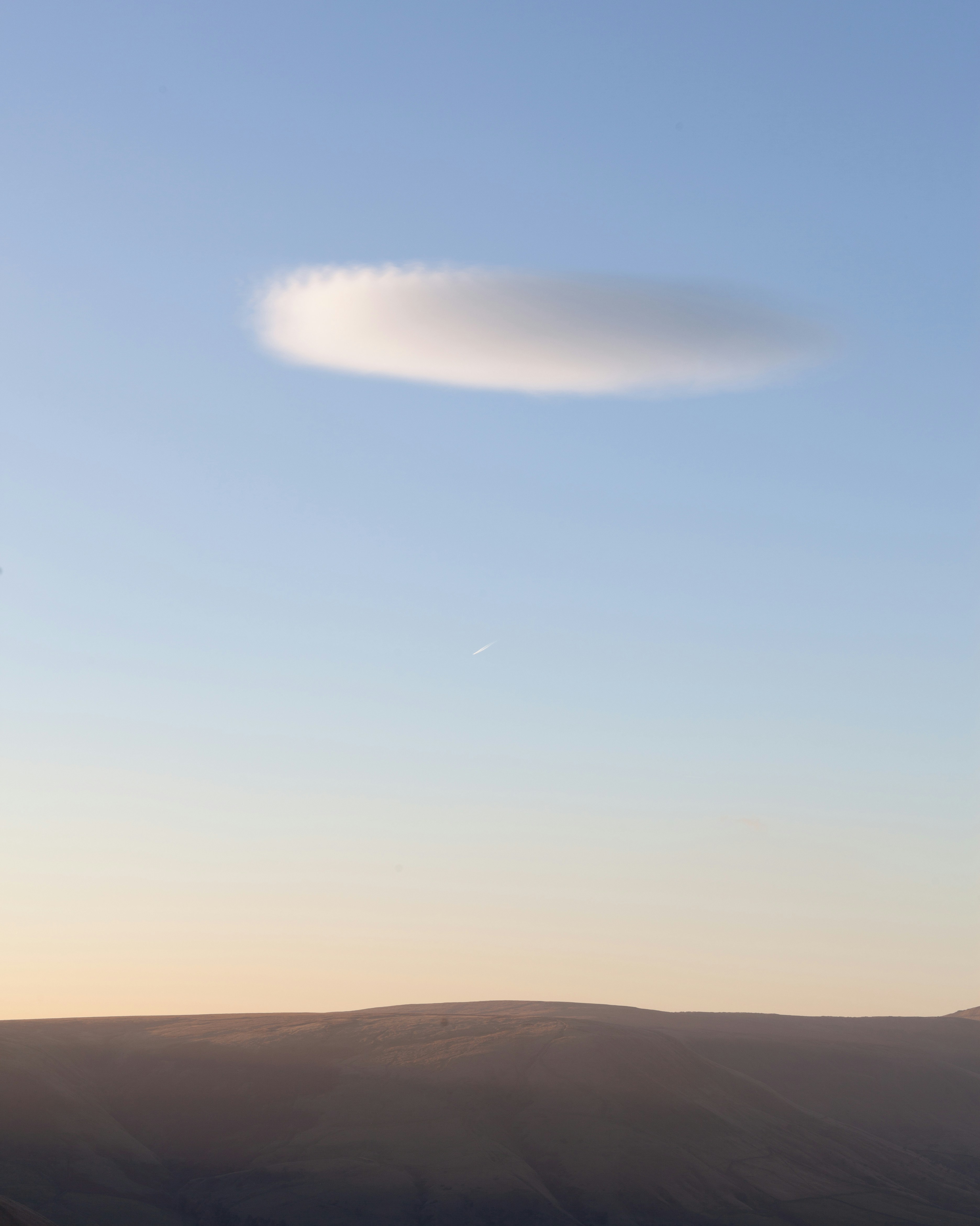 Blue Hour Over Dunes: A Lone Cloud Anchors the Quiet Horizon