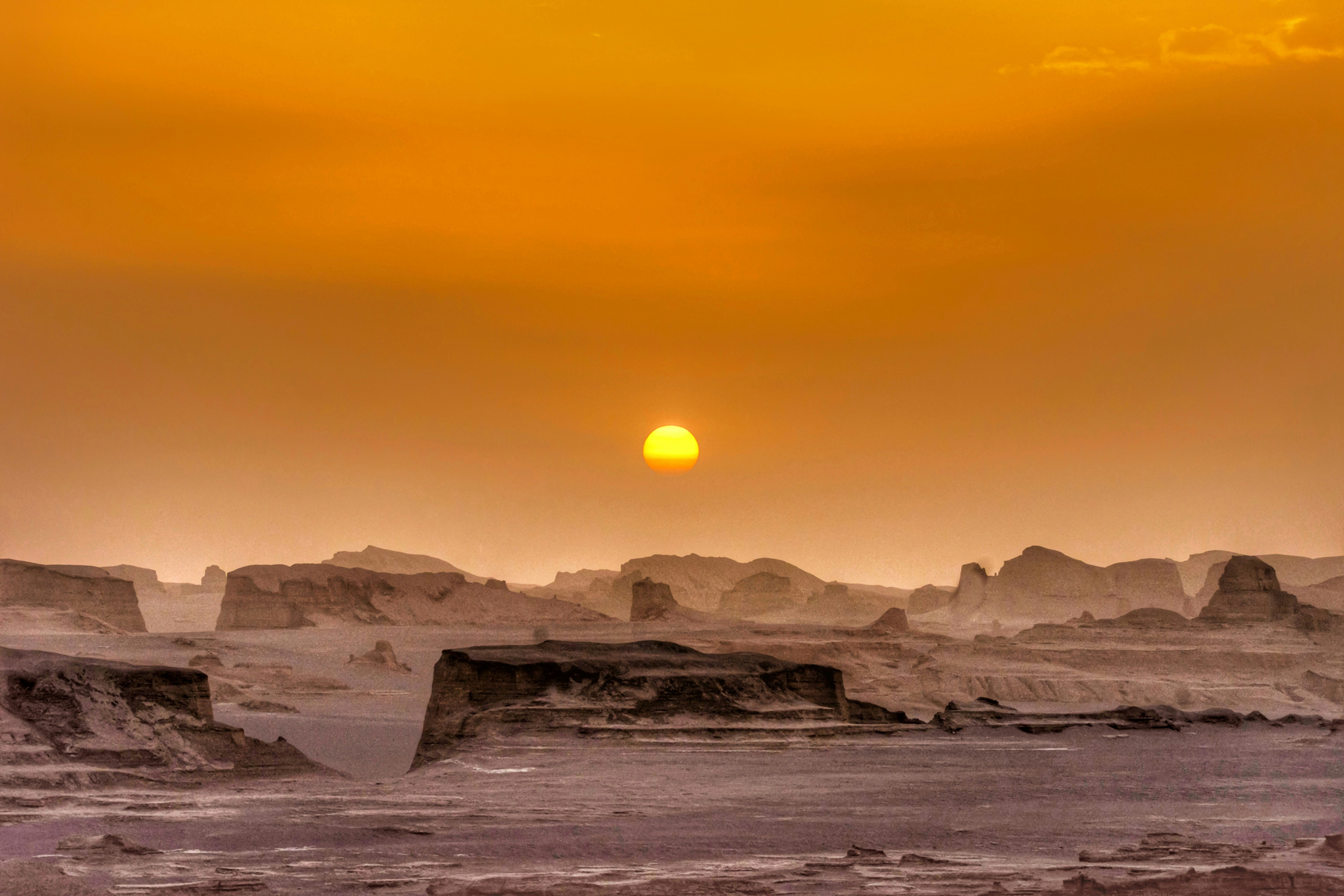 Sunlit Tides of Stone: Desert Dunes at Golden Hour