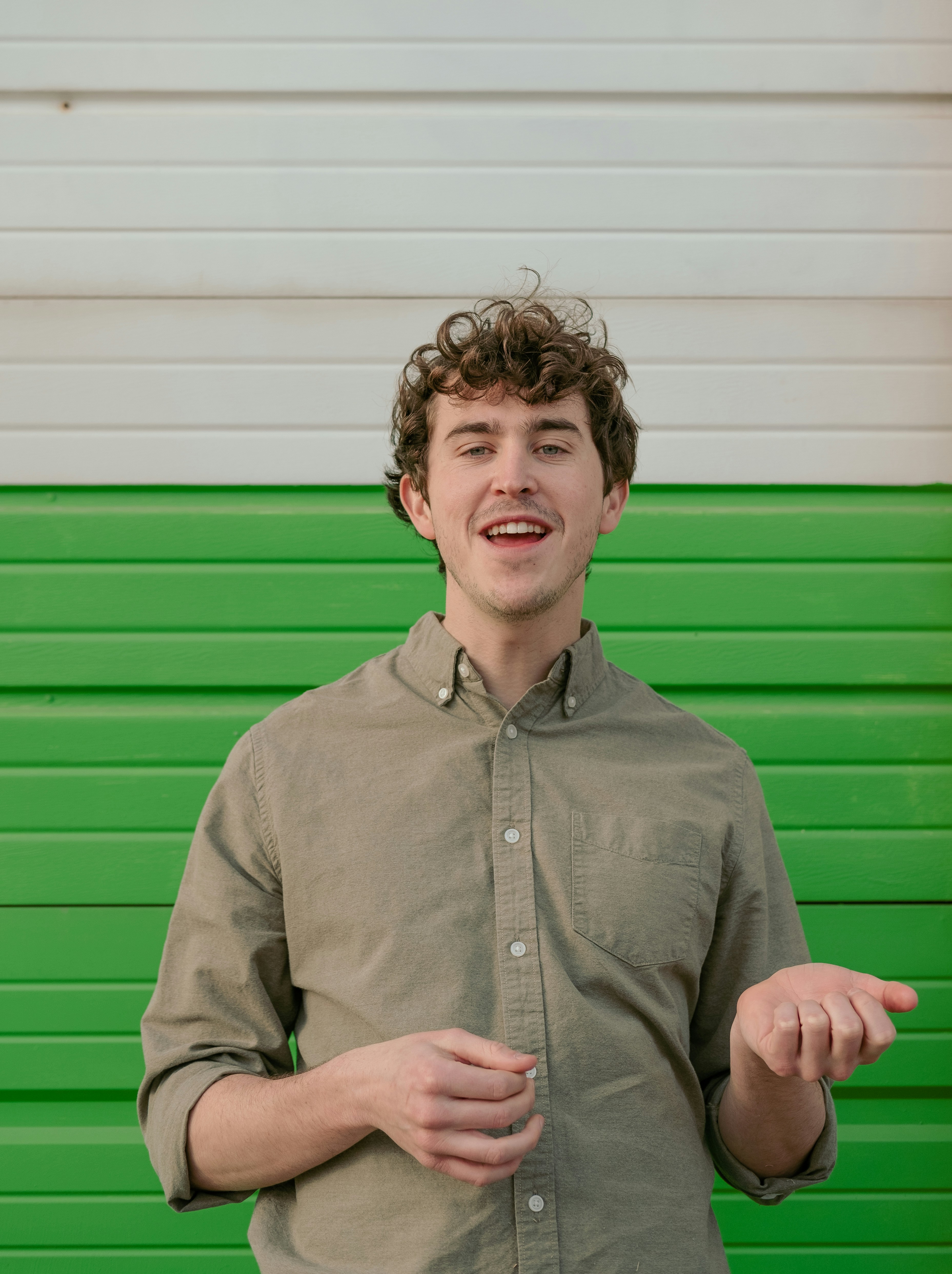 Casual Confidence Before a Lime Wall