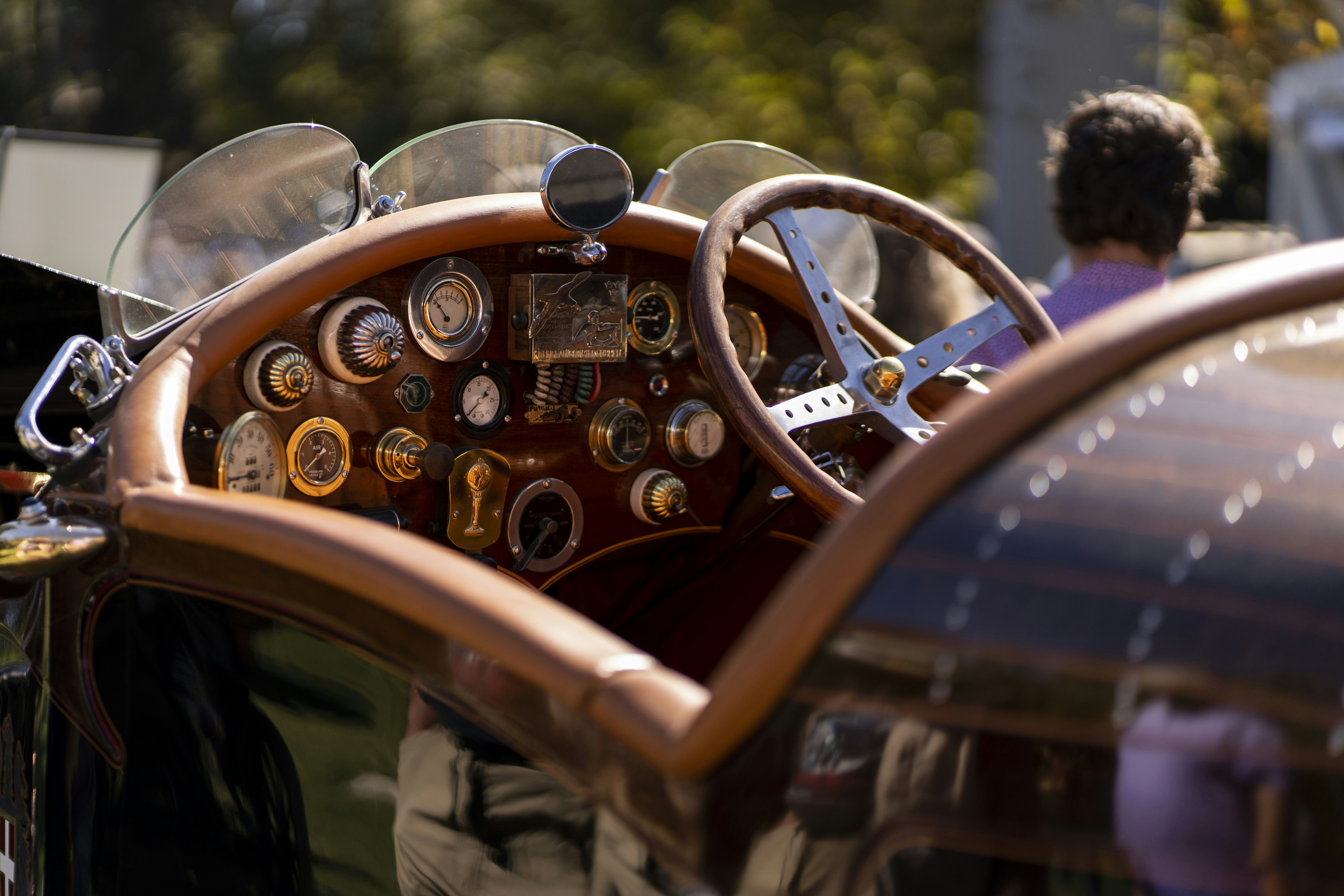 Sunlit Vintage Roadster Cockpit: Brass Gauges and Walnut Dashboard