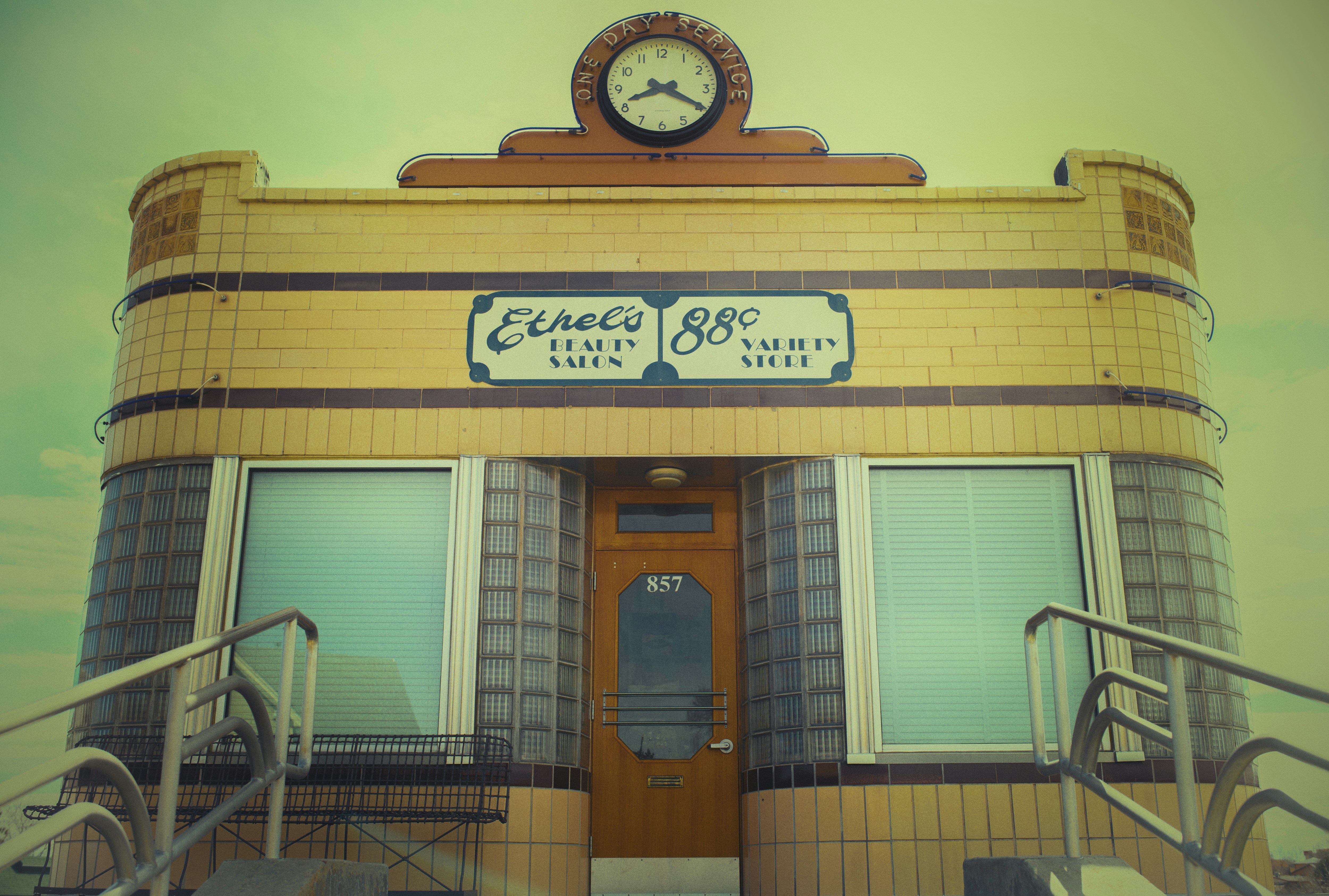 Art Deco-style building featuring Ethel's Beauty Salon sign and vintage clock, showcasing architectural charm and nostalgia.