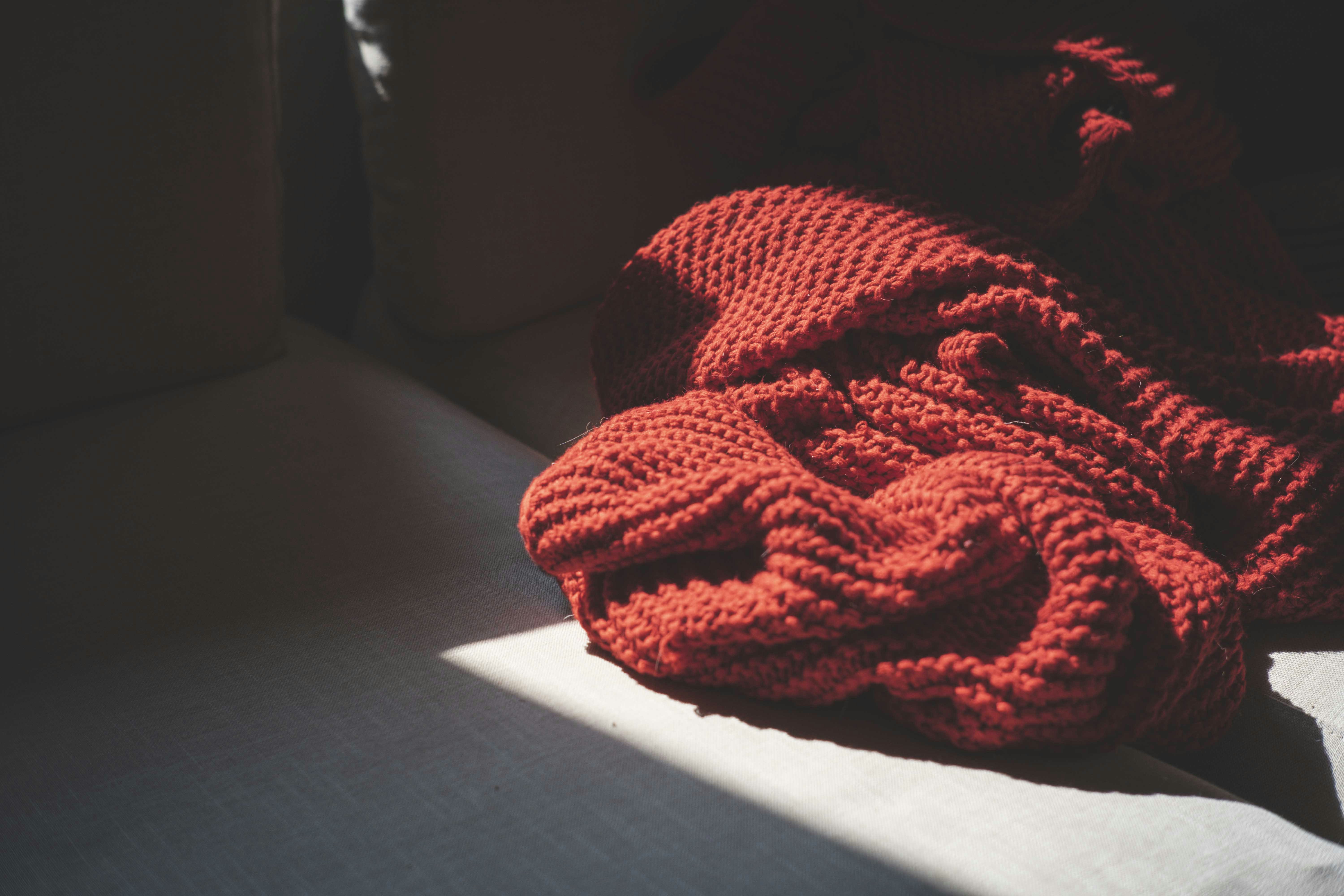 red knit textile on black textile