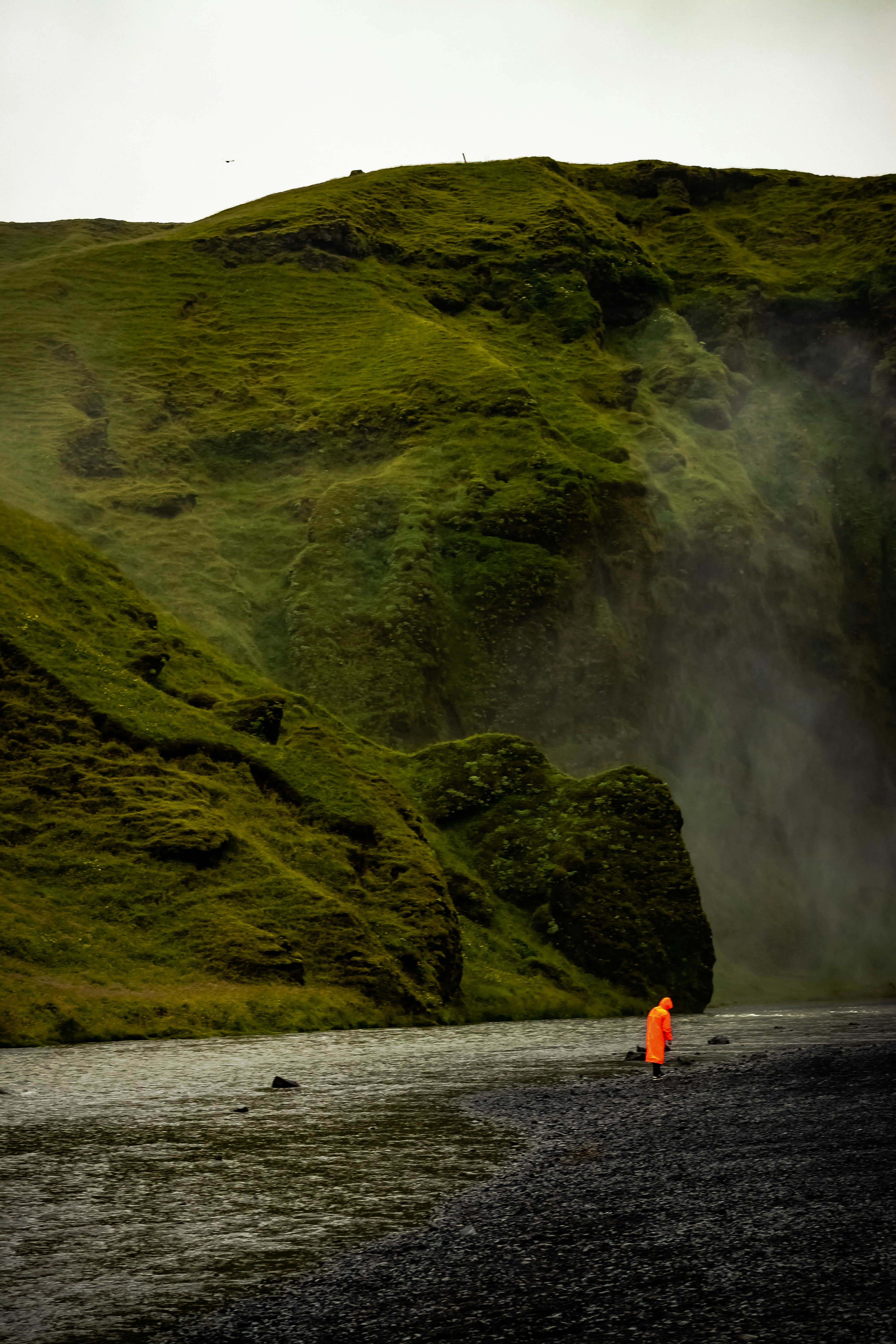 Emerald Cliffs and a solitary traveler in the mist