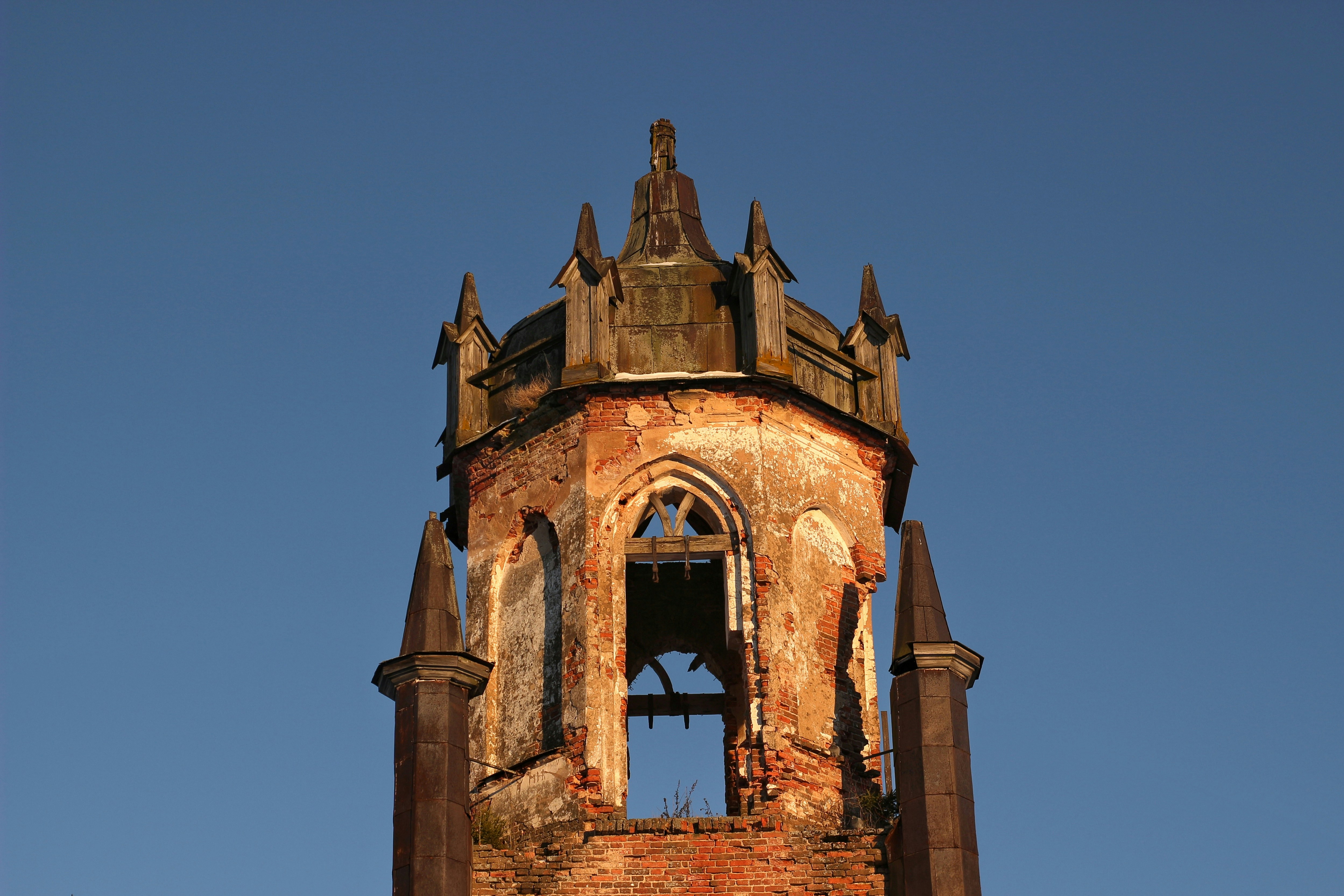 Sunlit Ruin: The Weathered Tower Reaching Toward a Clear Sky