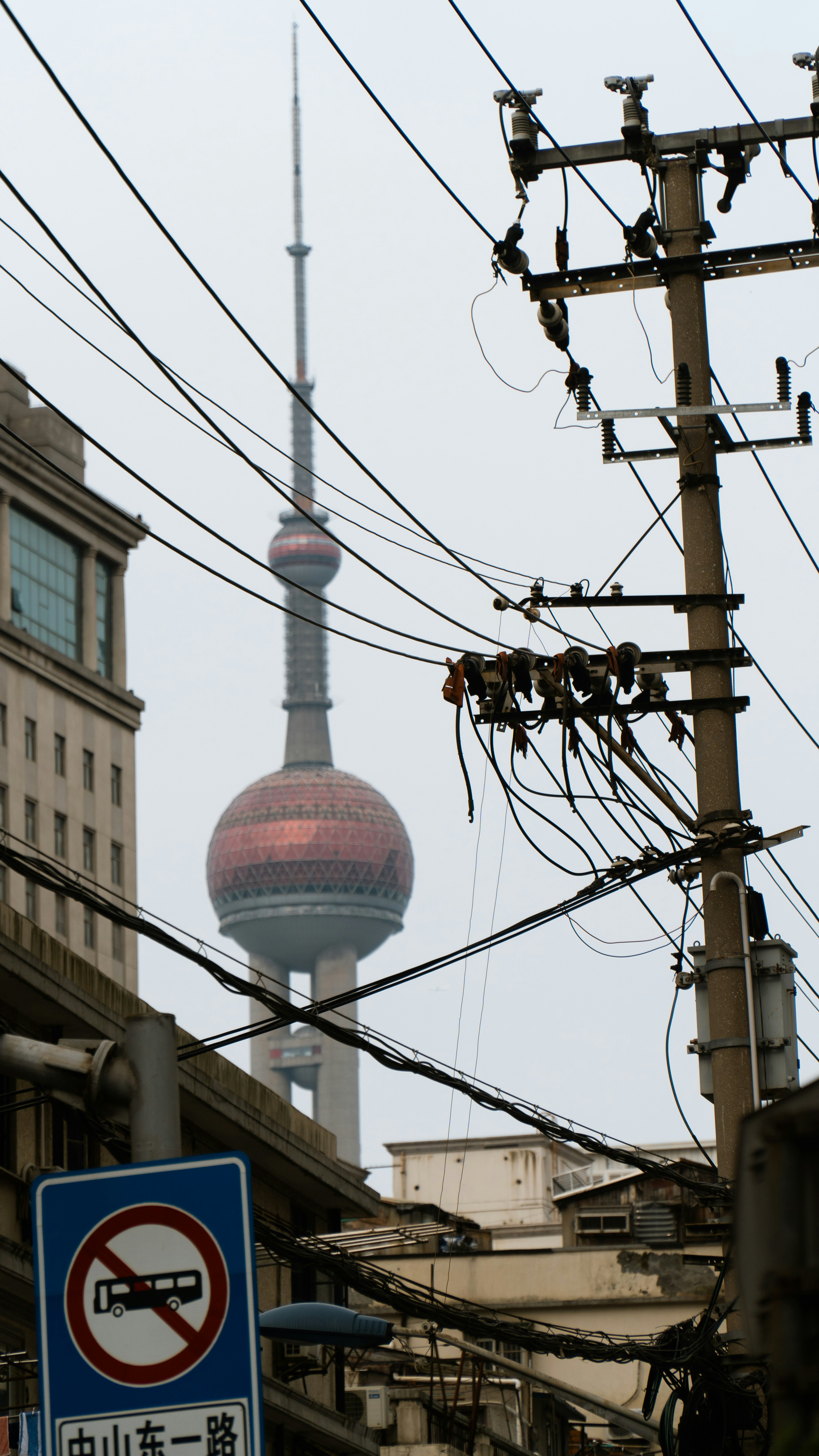 Crisscrossed Wires Frame the Pearl Tower in Shanghai