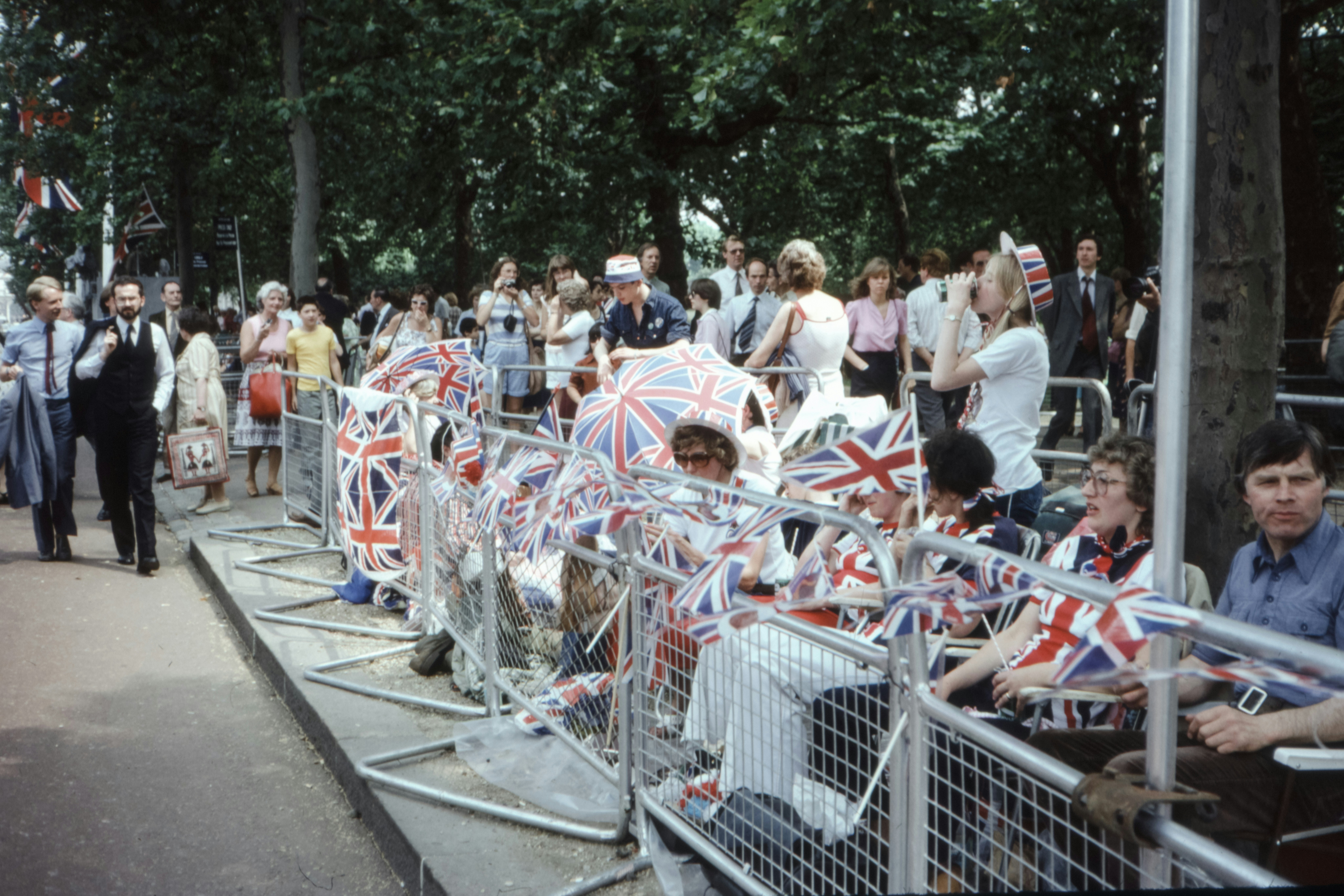 Street scene, London, to celebrate the Marriage of Prince Charles and Princess Diana, 1981. 1980s 35mm film slide photo | people standing on gray concrete road during daytime