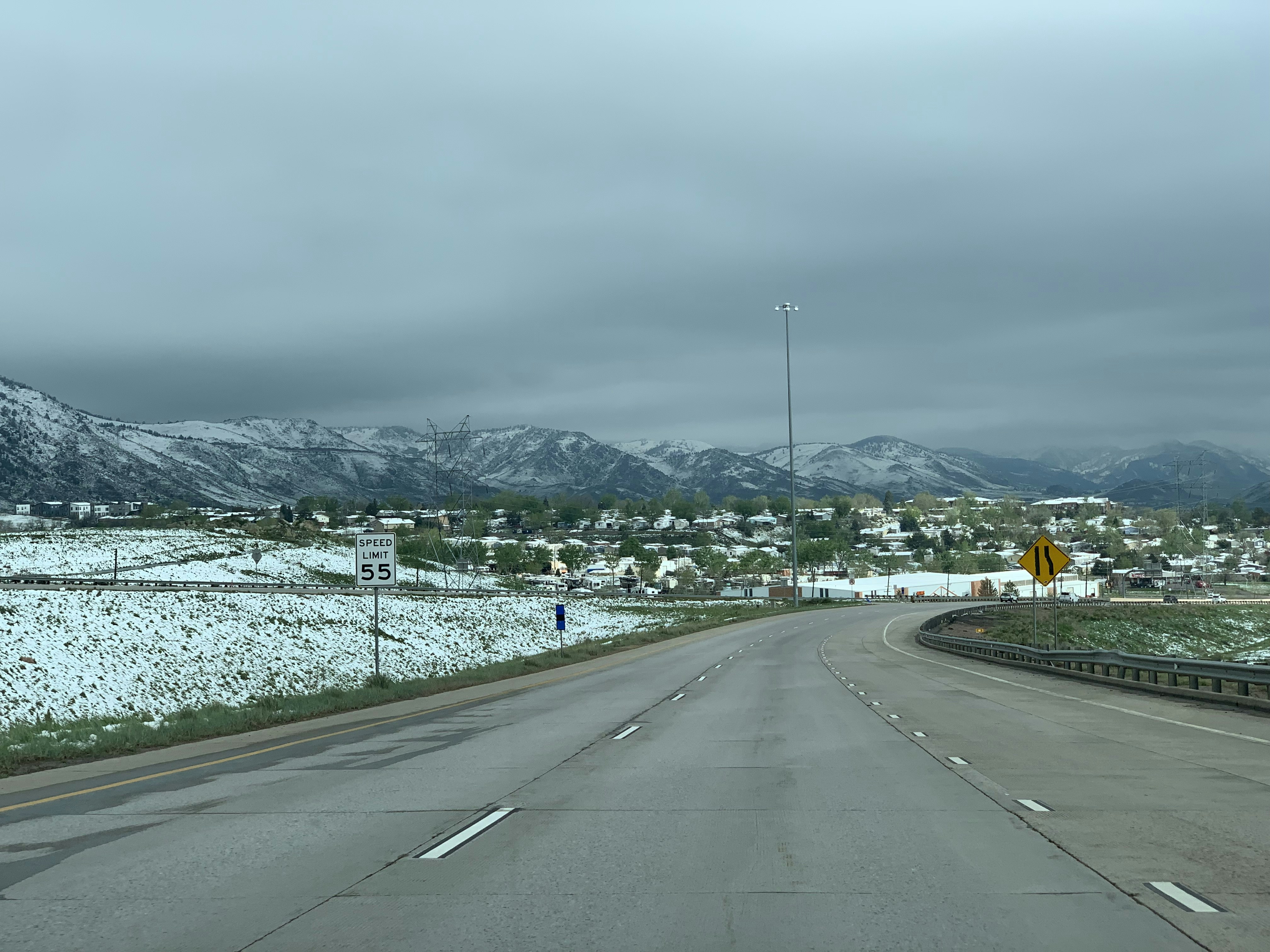 Gray concrete road near green trees and mountain during daytime photo ...