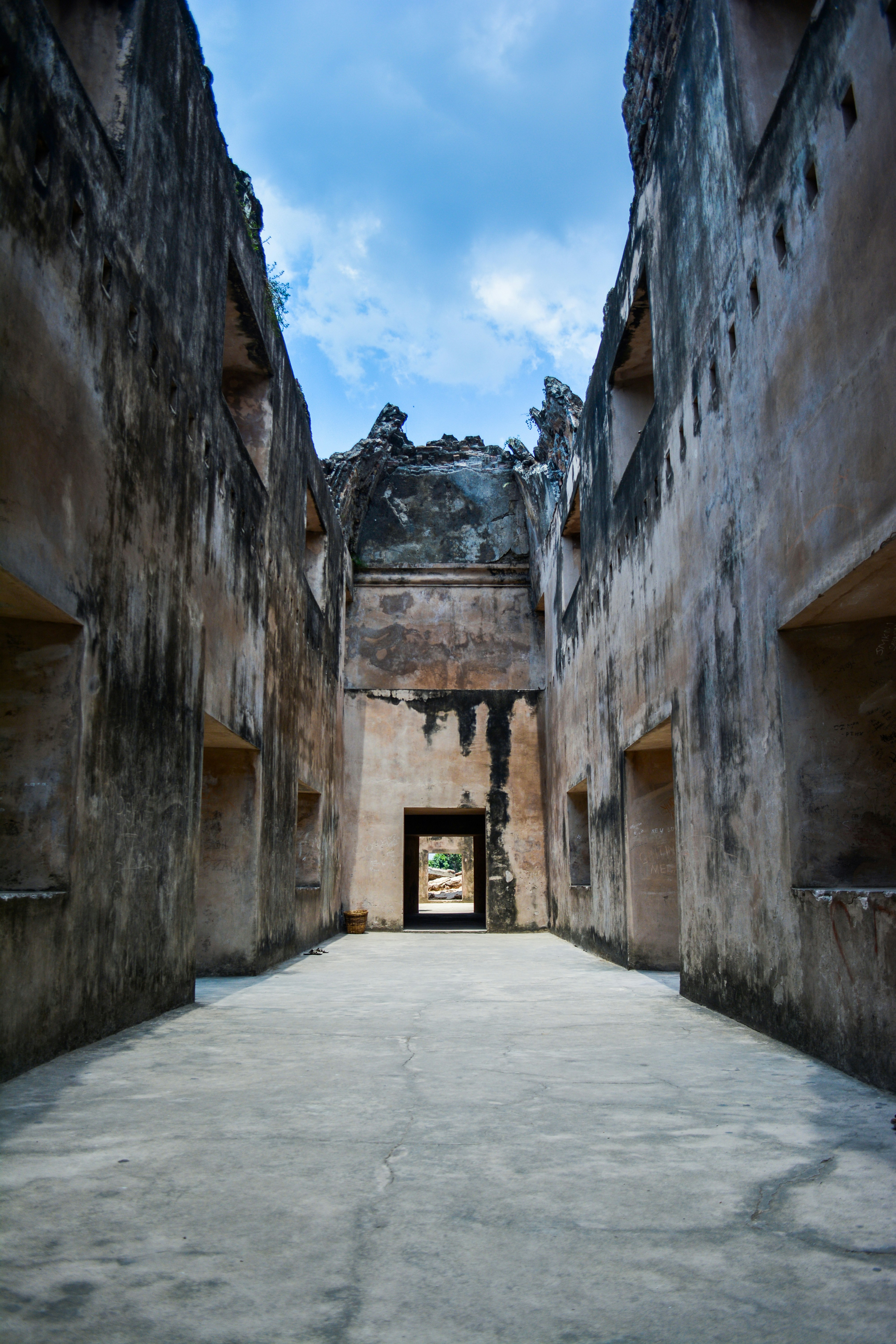 Symmetry and Sky: A Ruined Corridor Reaches a Framed Portal