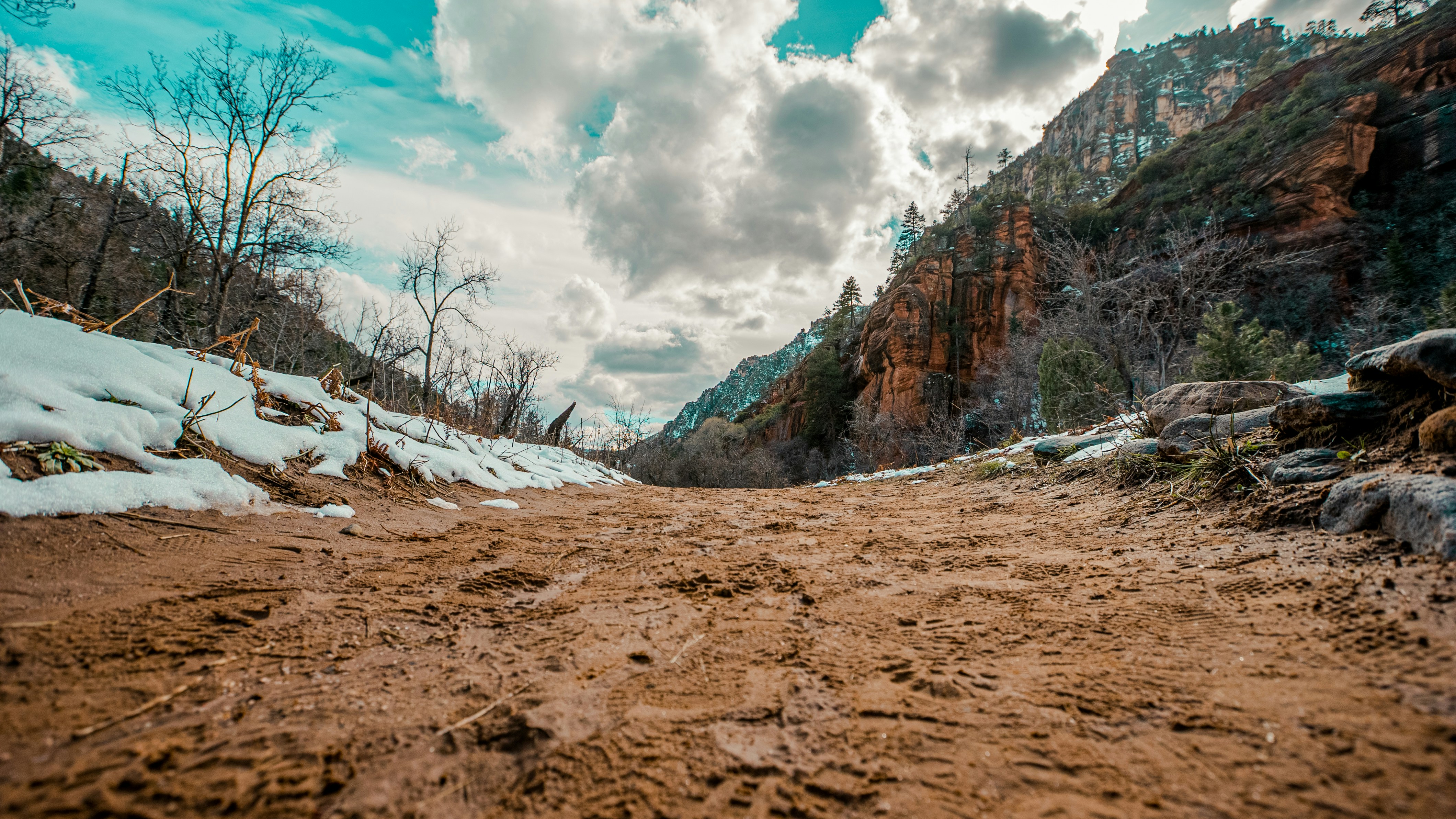 Carved Path: Snow-Laced Gorge Under a Turquoise Sky