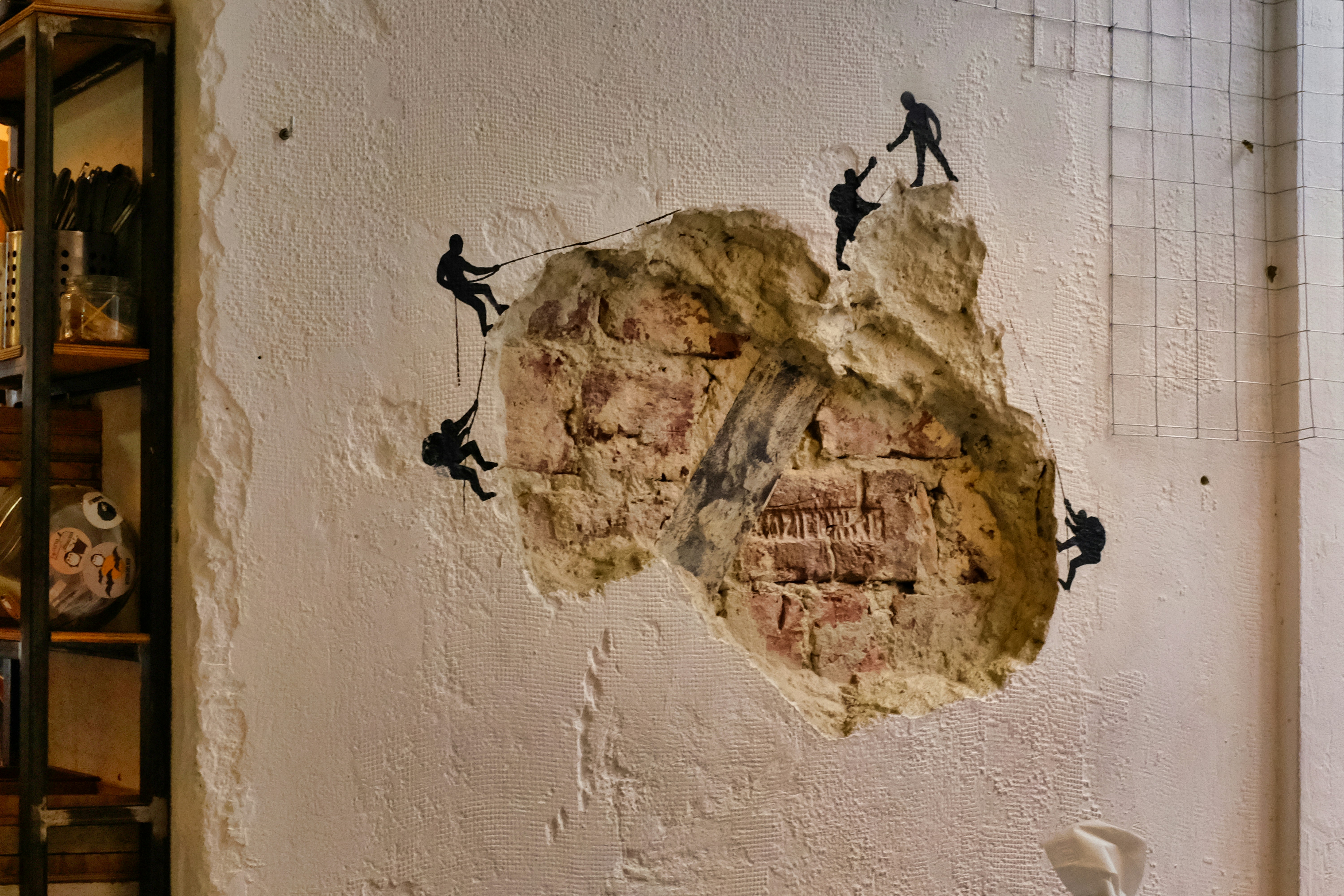 Graffiti Silhouettes Thread the Wall’s Wound