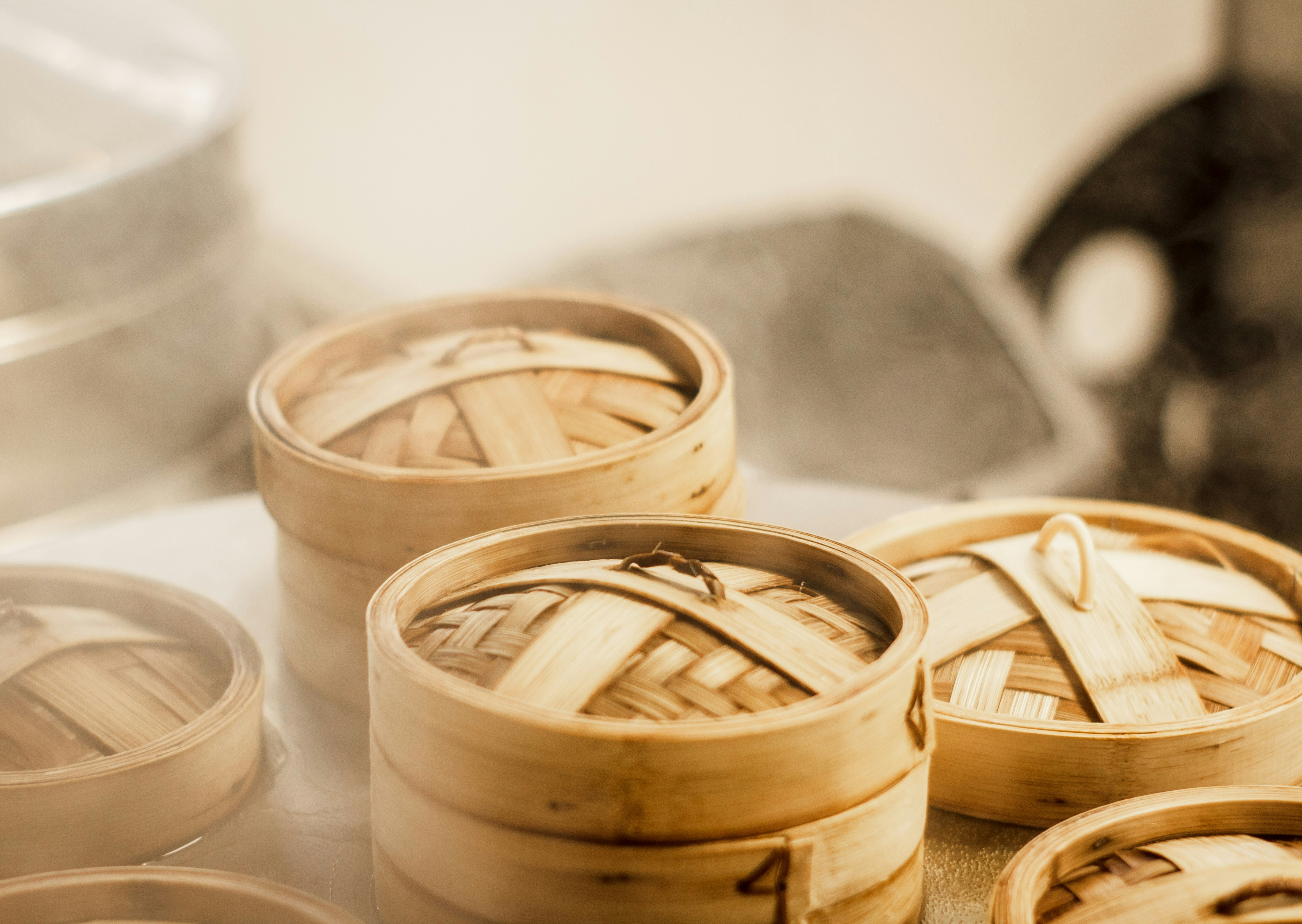 Amber Hearth: Close-up of Bamboo Steamers in Quiet Kitchen Light