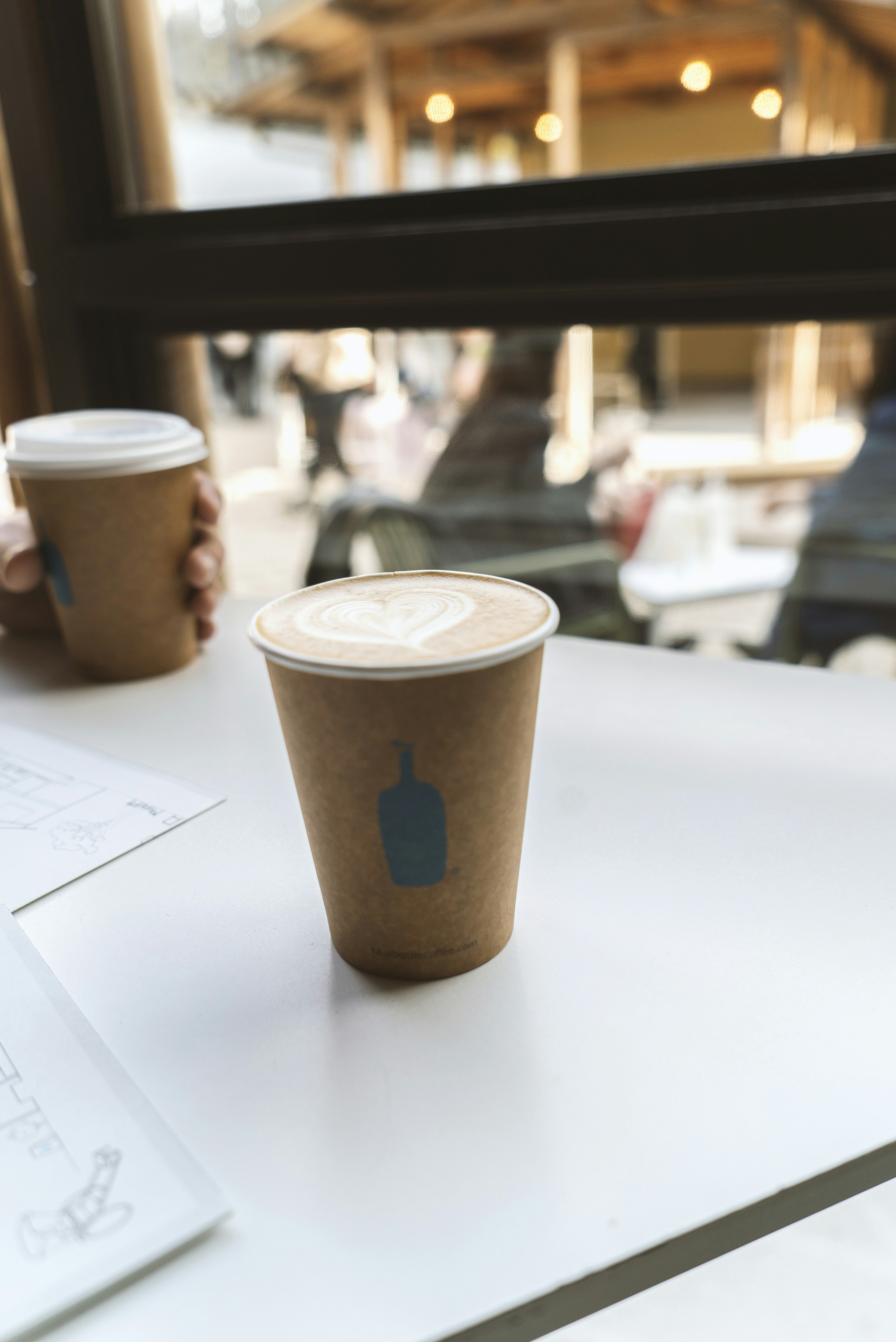 Heart of Foam: Latte Art Framed by a Quiet Café Window