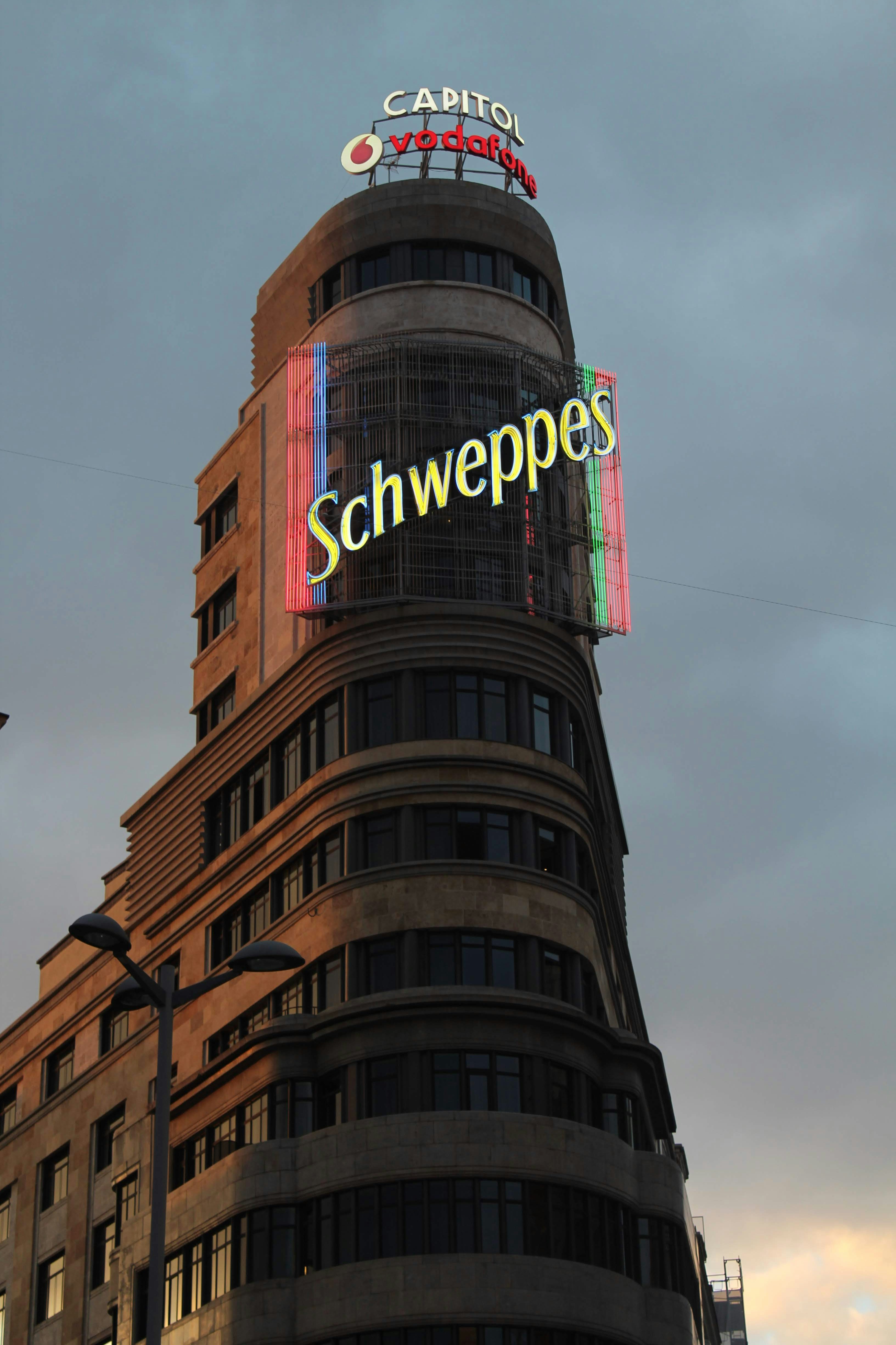 Schweppes Sign on a Curved Downtown Tower
