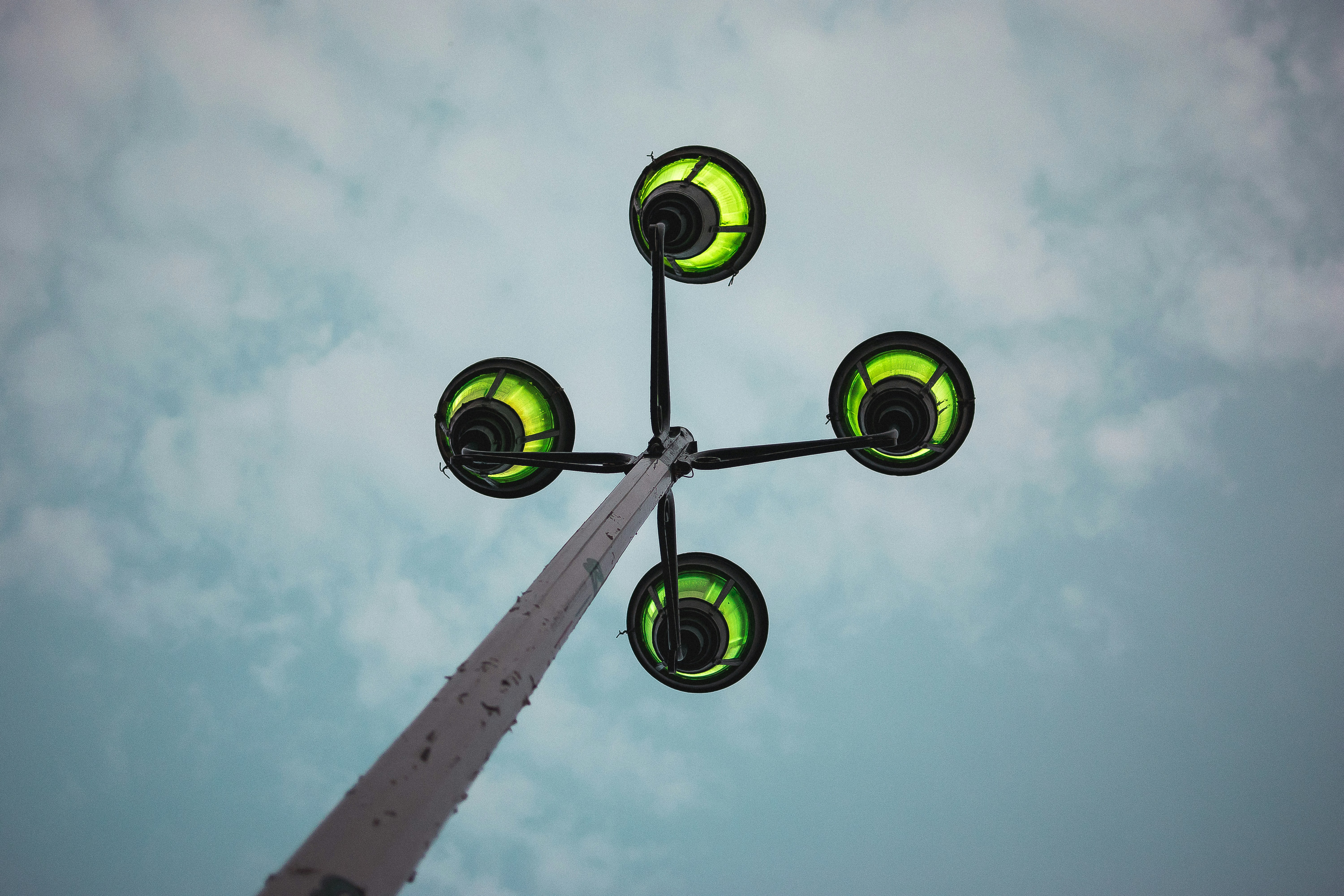 Neon Crossarms: Four Green Orbs Guard the Skyward Lamp