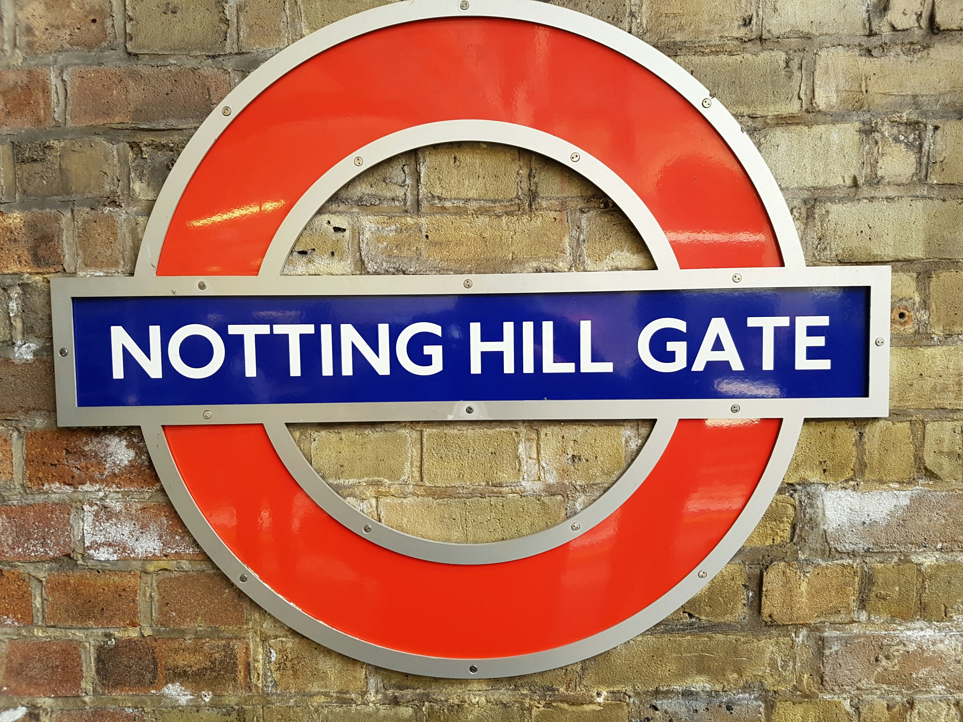 Notting Hill Gate Roundel: Brick Wall Canvas with a Blue Banner