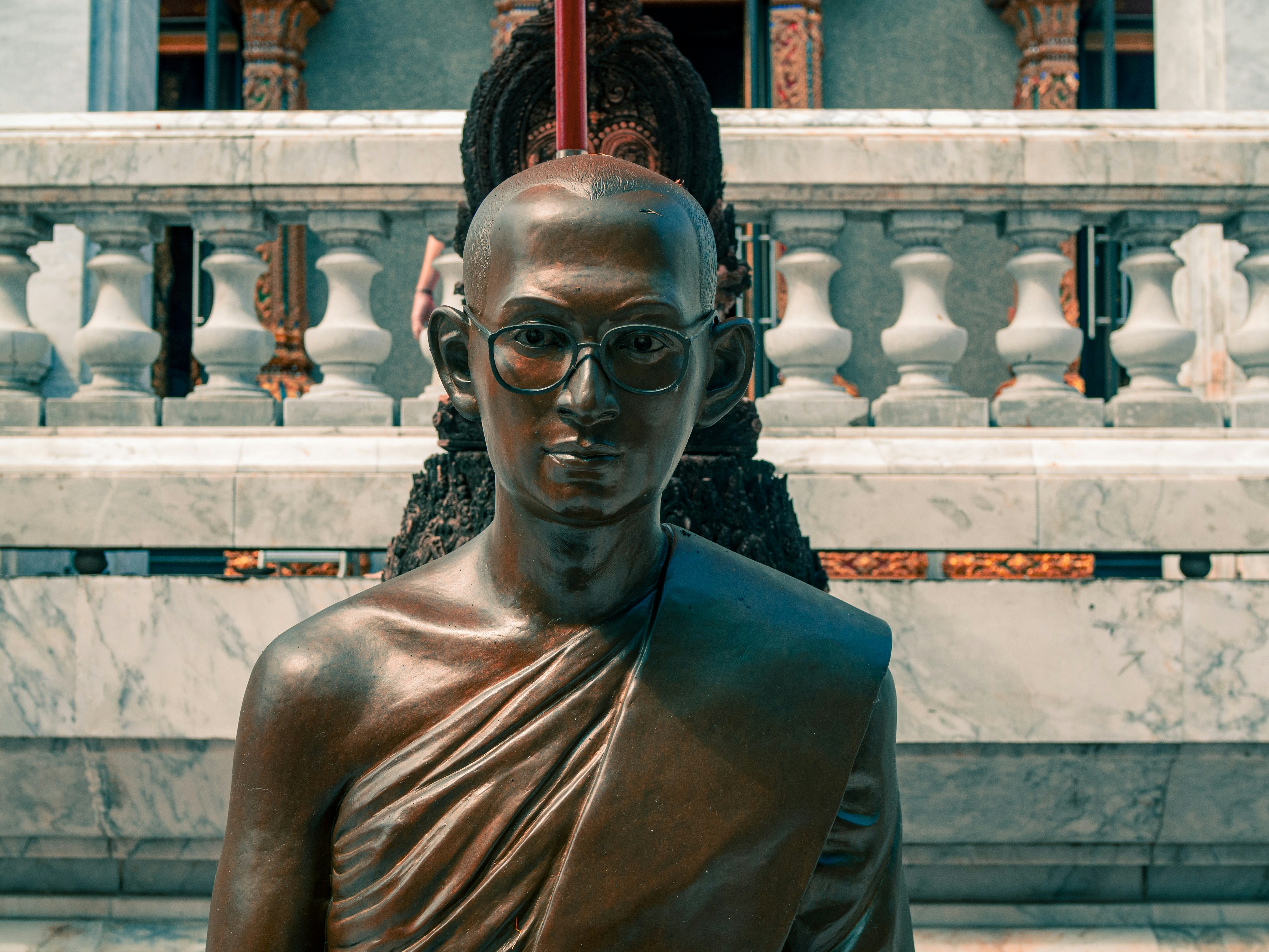 Patina Portrait: Bronze Monk Framed by Marble Balustrades
