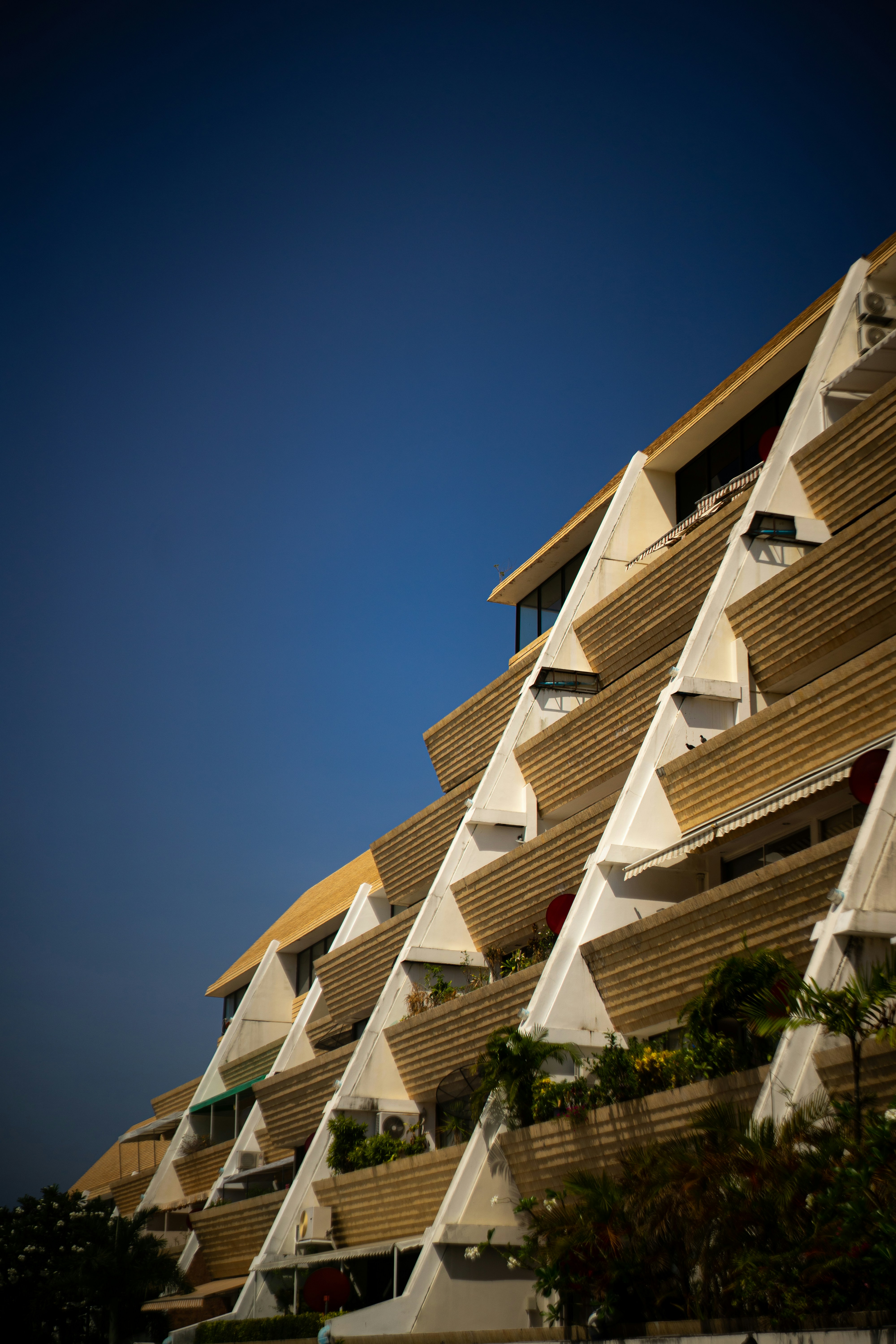 Angle of Modernity: Diagonal Balconies Climb a Sunlit White Facade