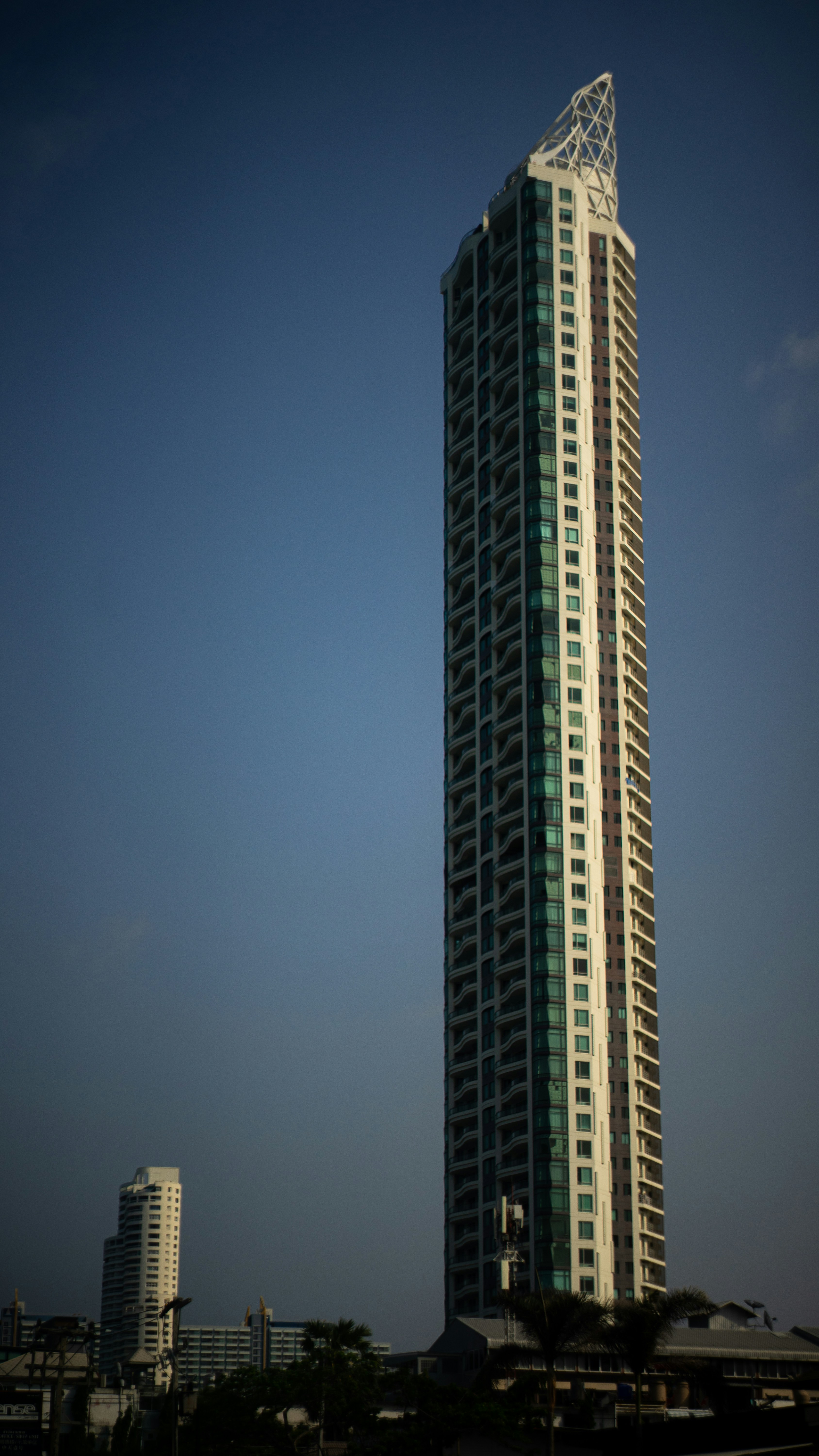 Azure Spire Rising: a slender glass tower against a cloudless sky