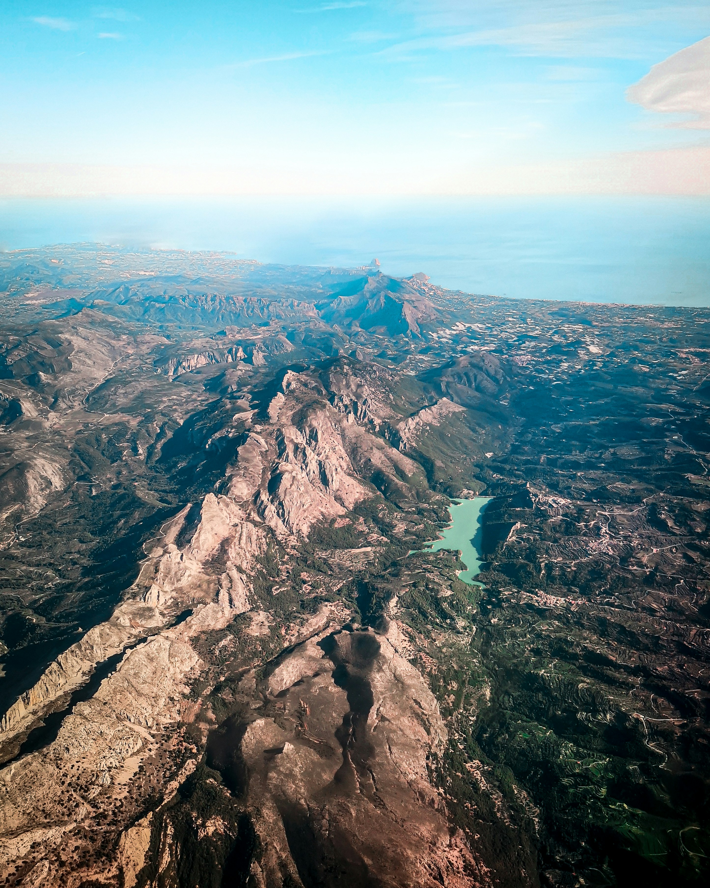 Aerial Rift: Mountain Spine Carves a Striated Canyon Toward a Distant SeaJorge Fdez
