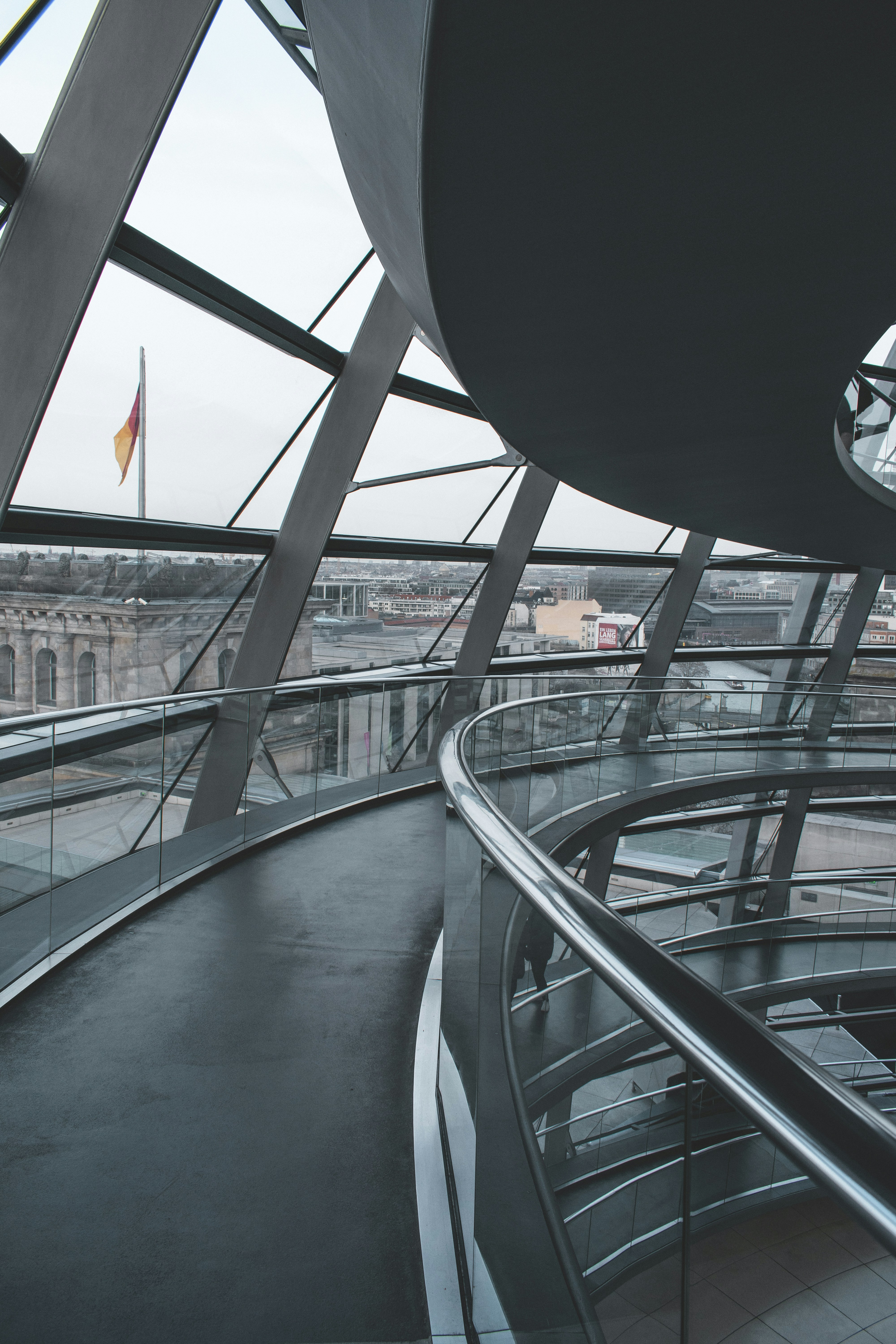 Curved Glass Walkway with Cityscape Beyond
