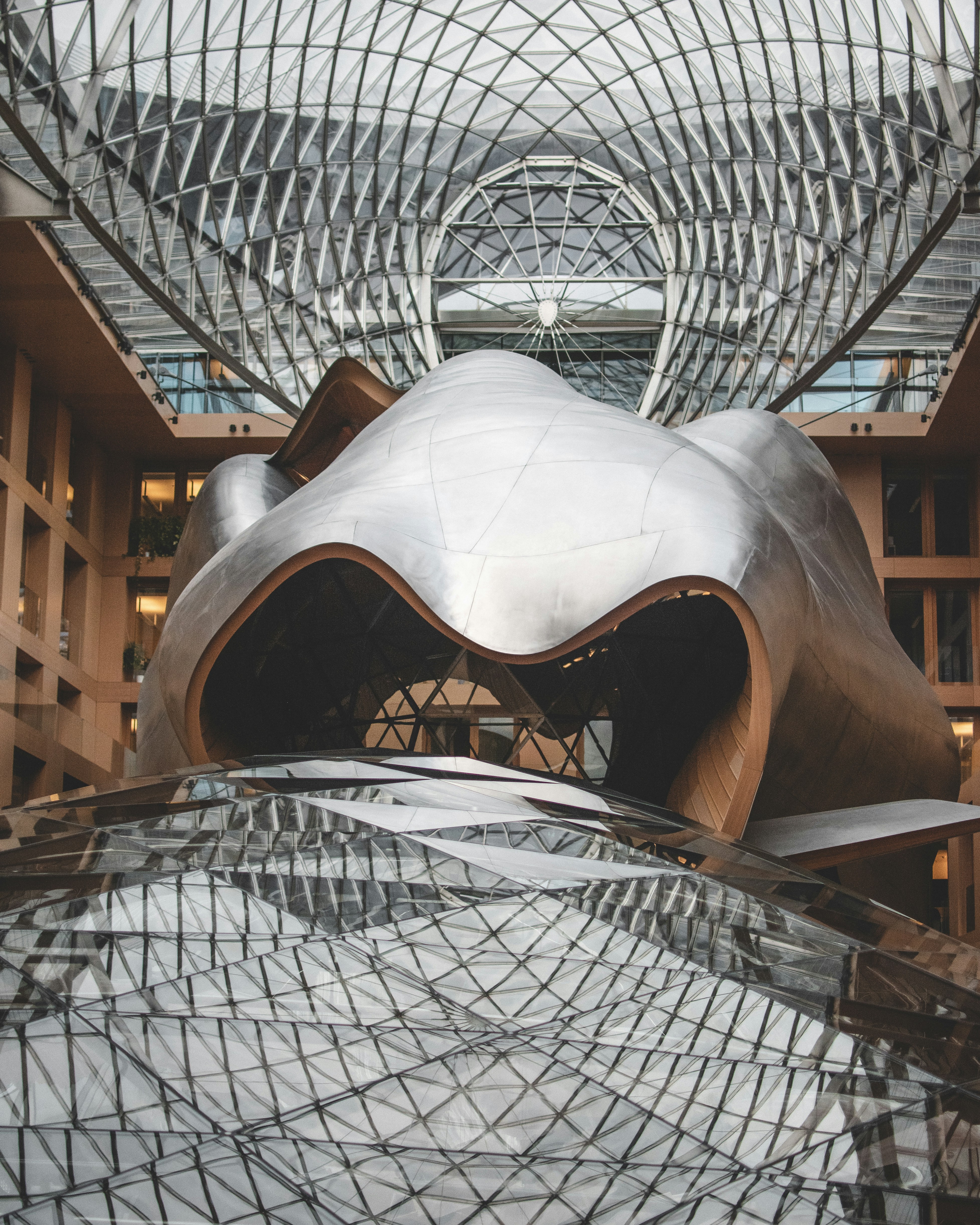 Curved Metal Form in a Glass Cathedral