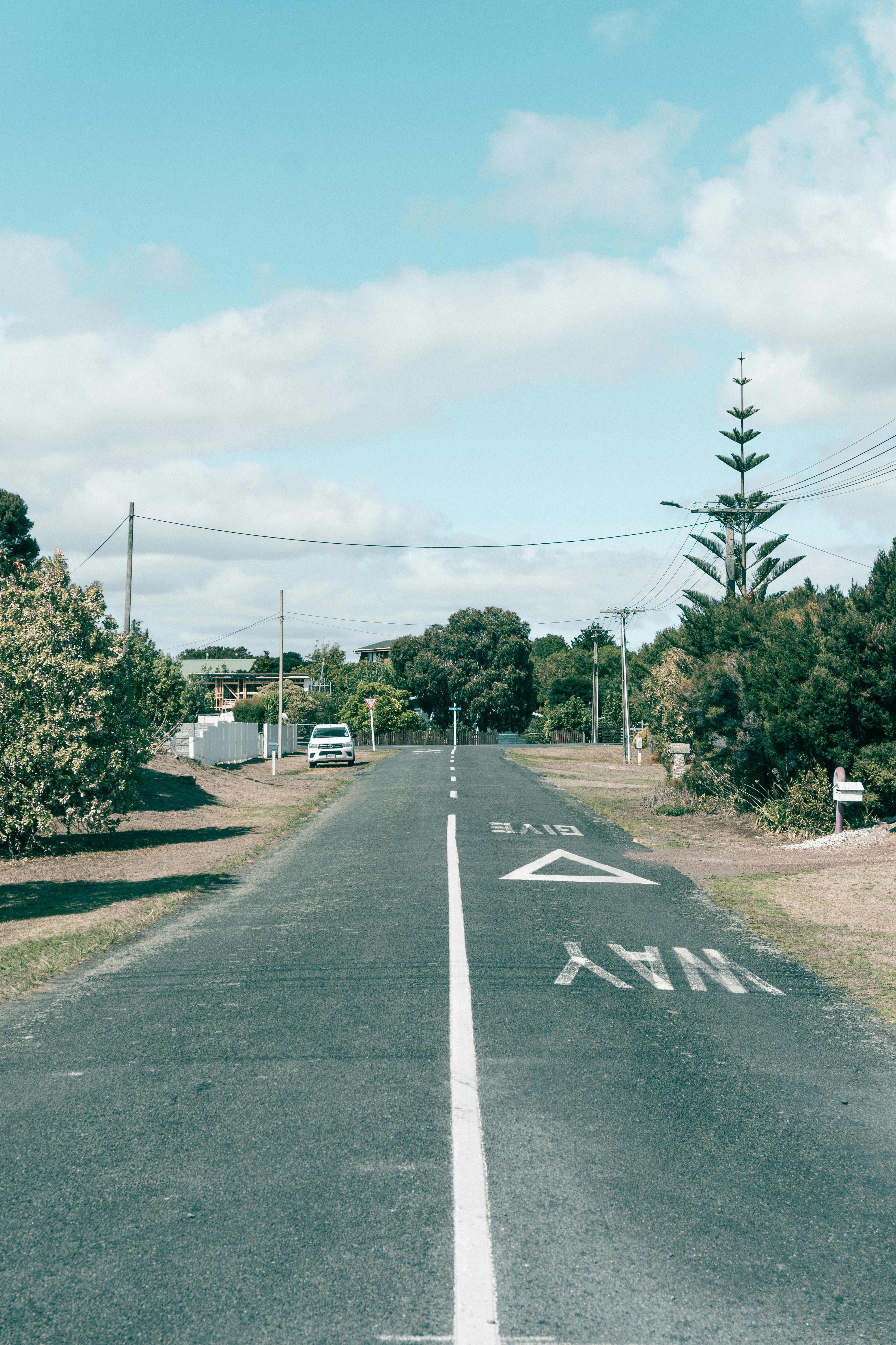gray asphalt road with no cars during daytime