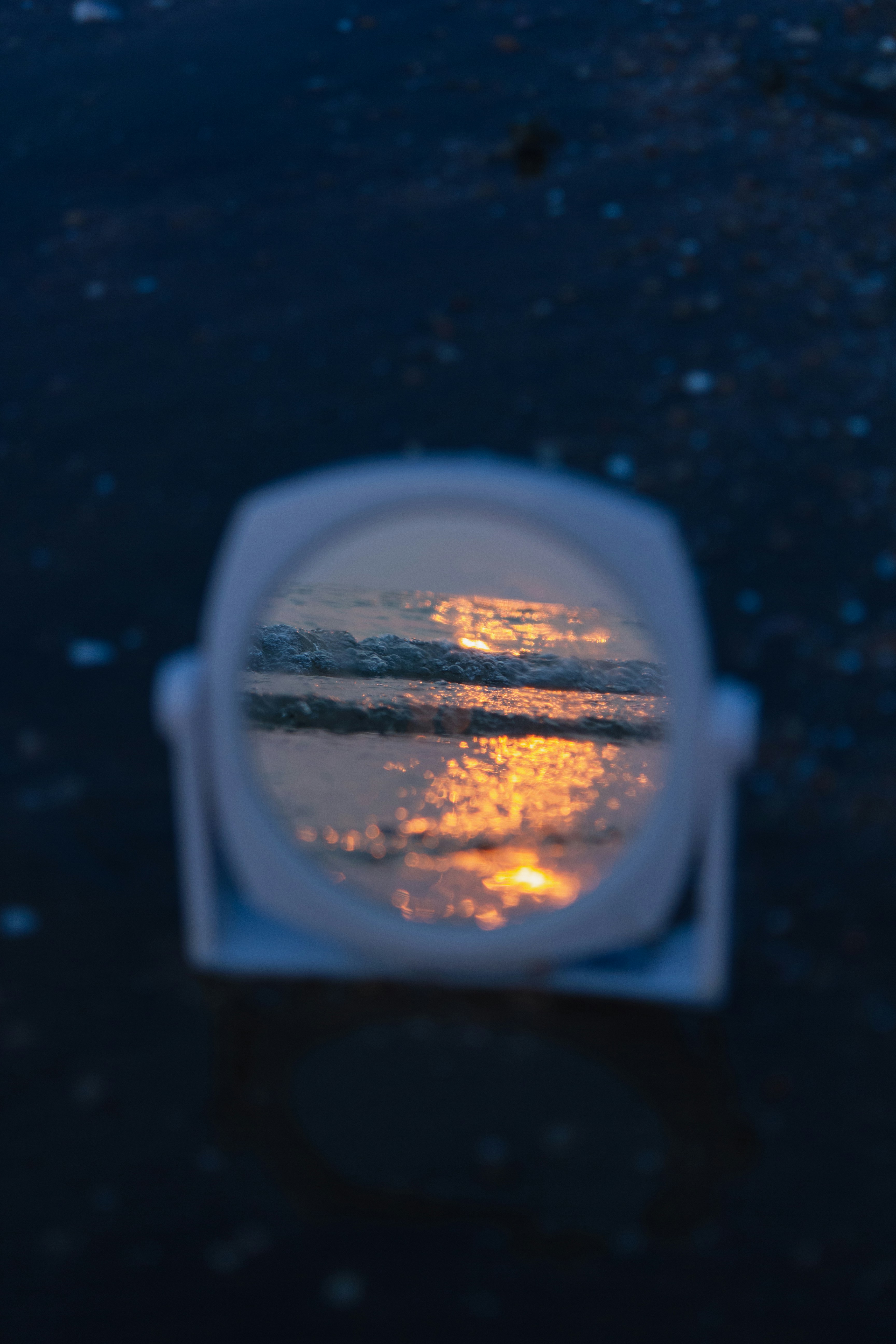 Sunset in a Pocket Viewfinder: a warm reflection framed by a tiny lens