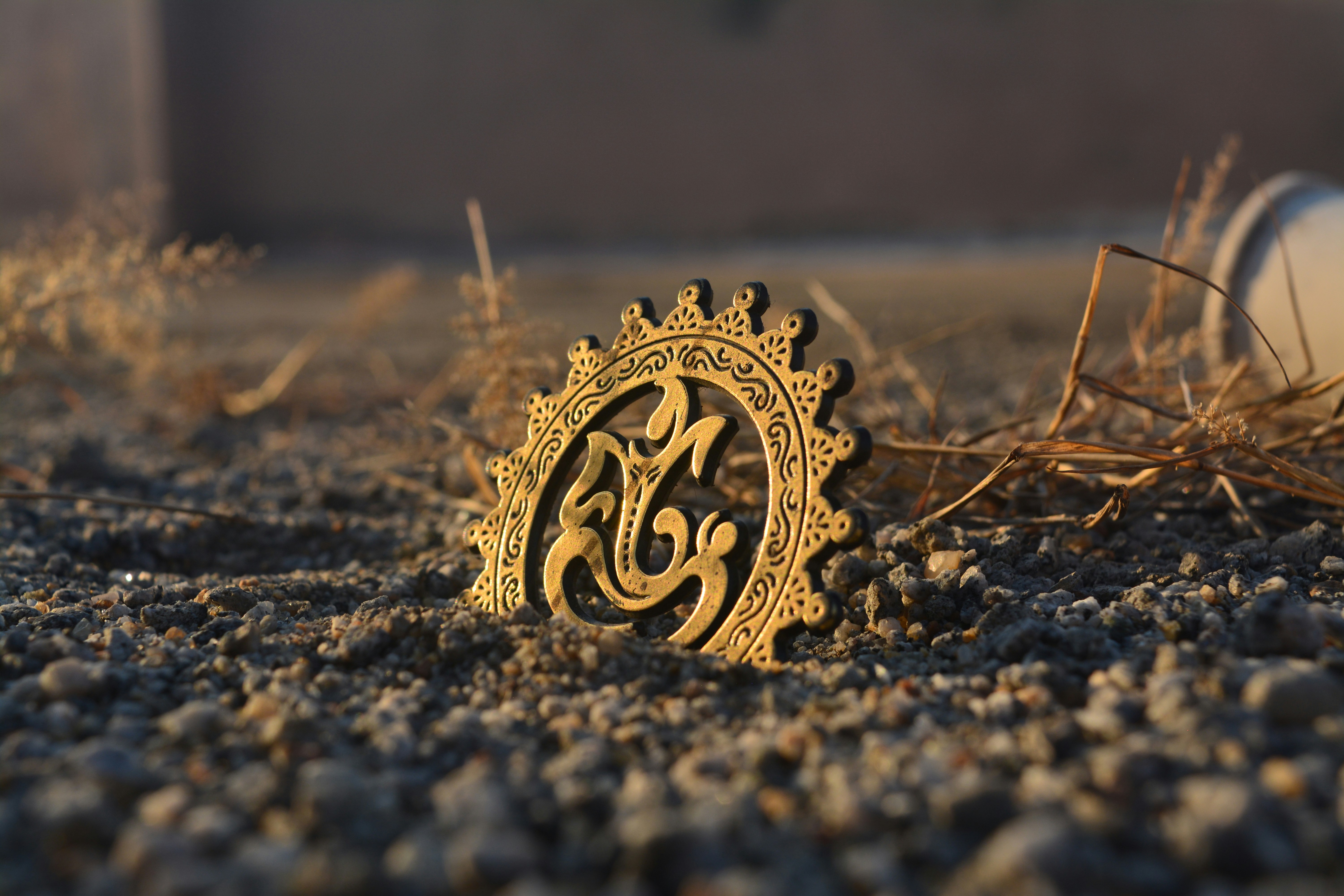 Emblem in Amber: A Filigreed Gear Resting on Desert Gravel