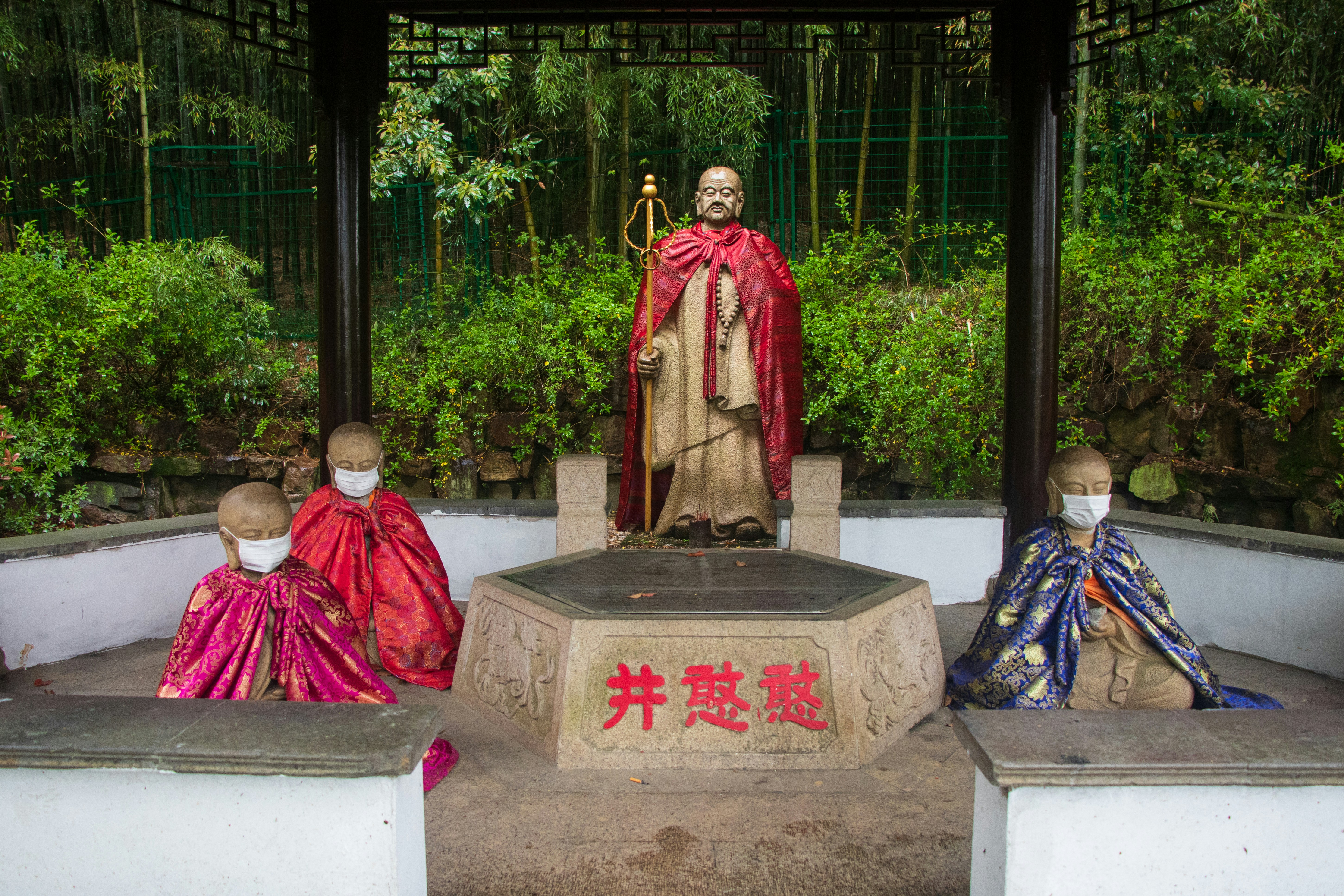 Man in red robe sitting on gray concrete bench photo – Free Suzhou ...