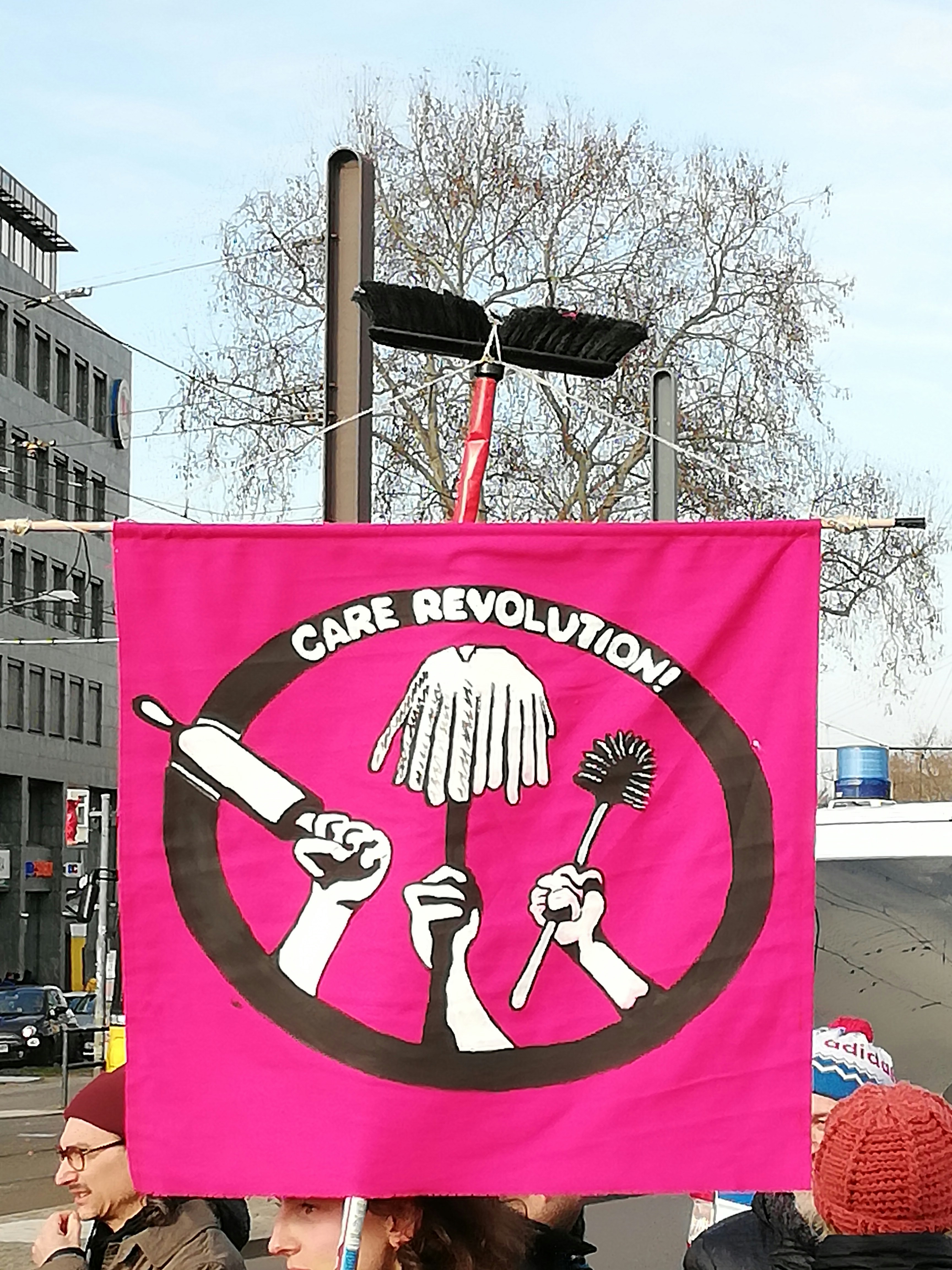 Care Revolution Banner: Pink Protest in an Urban Street