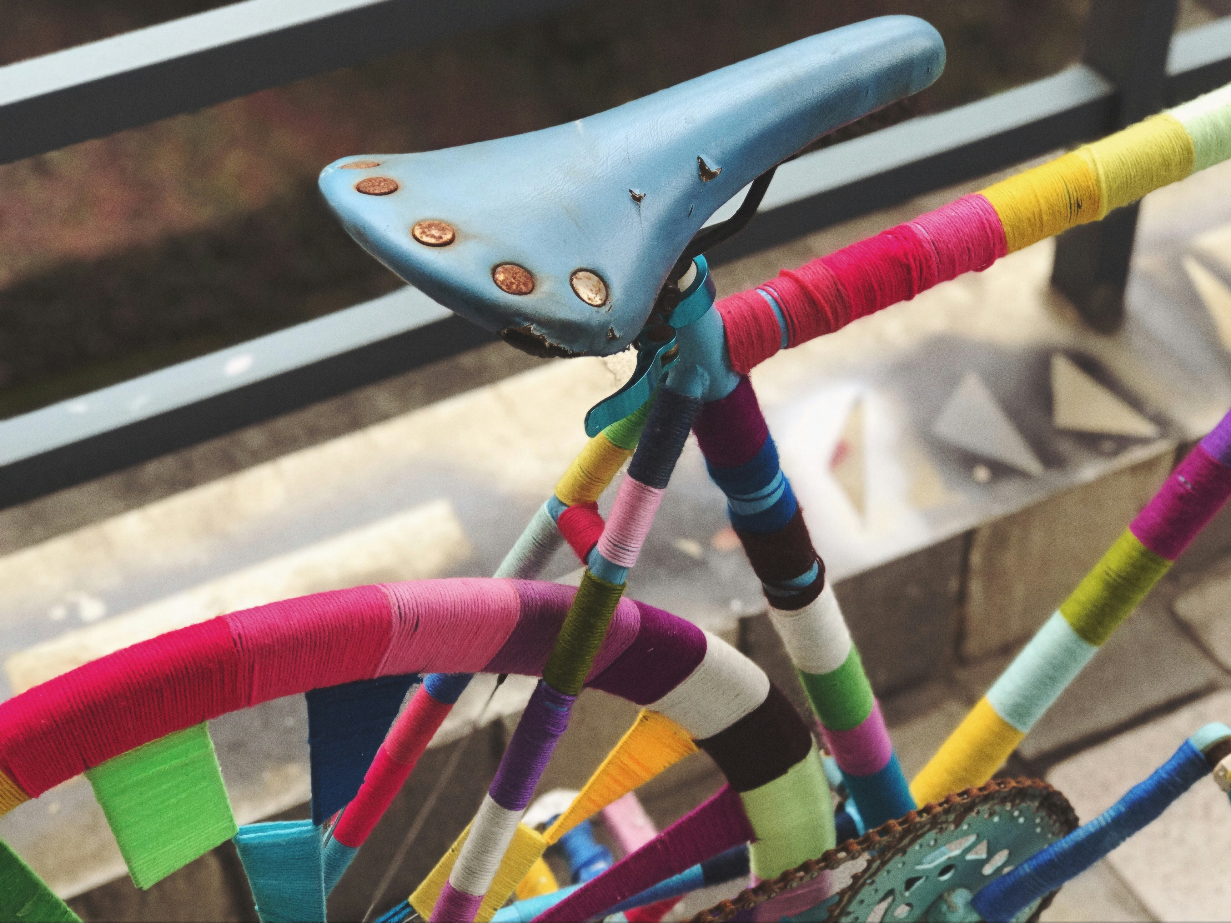 Colorful Bicycle Frame Tapestry Under a Rail