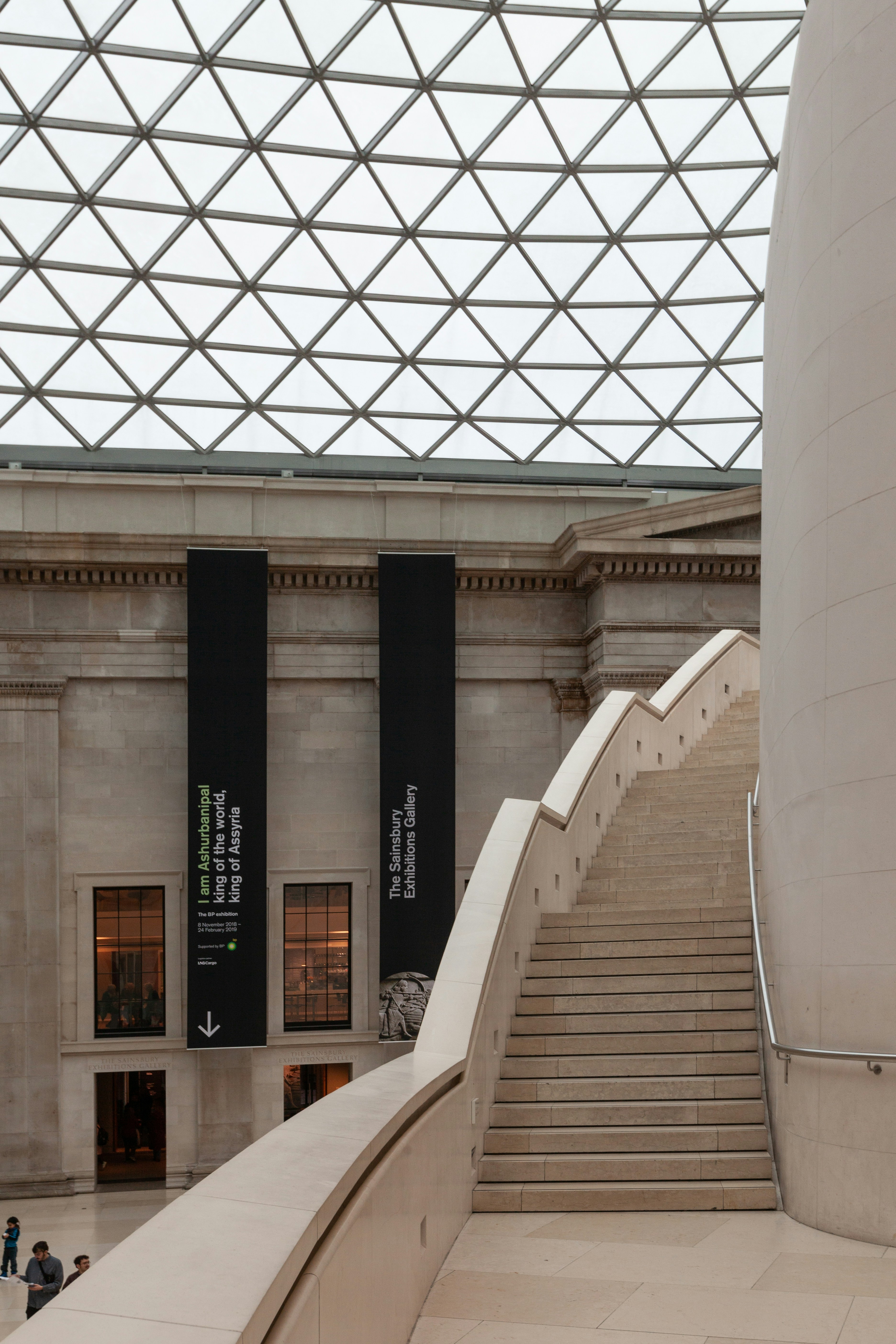 Atrium Geometry: Bannered Wall Under a Diamond Glass Ceiling