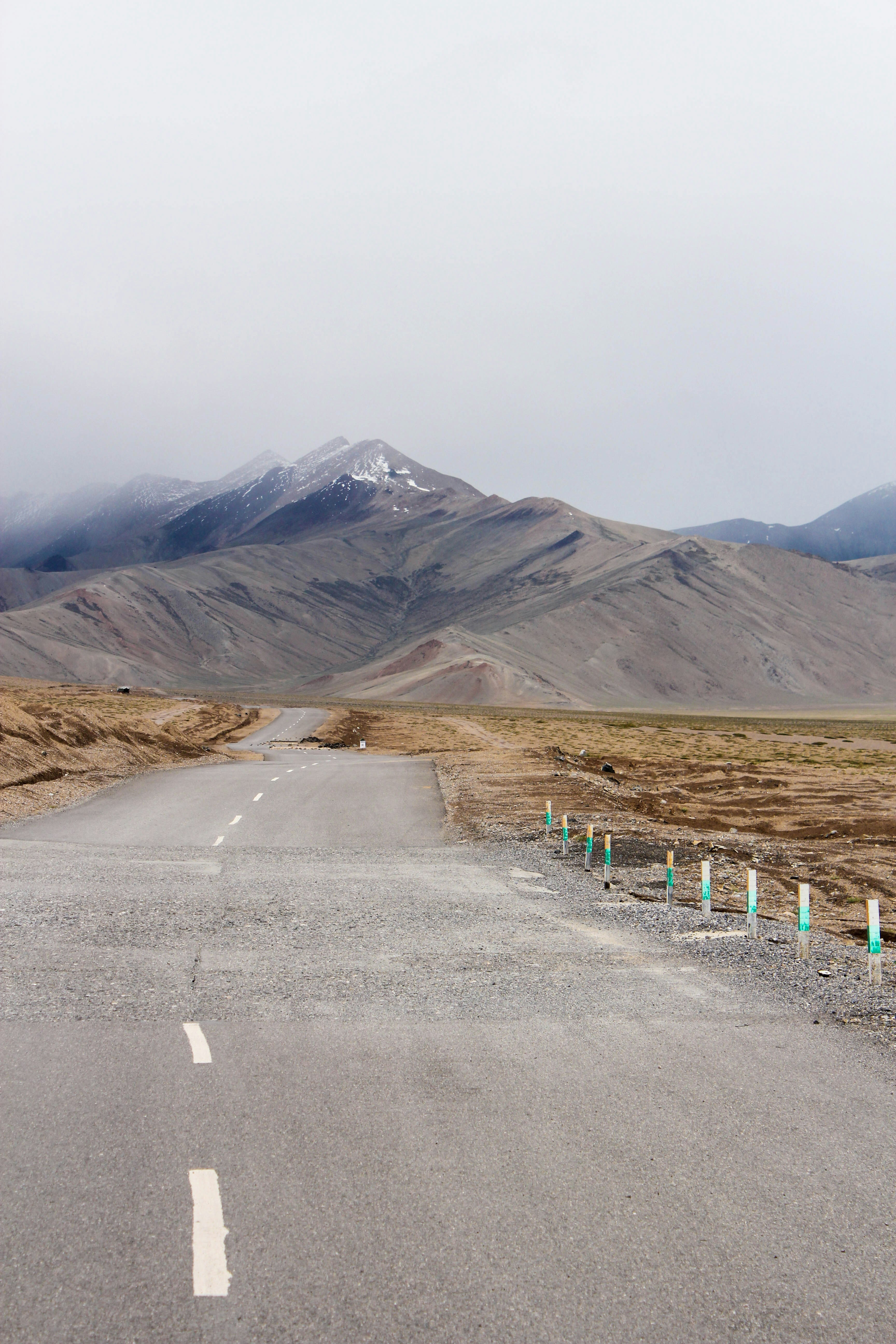 Gray asphalt road near brown mountain during daytime photo – Free Grey ...