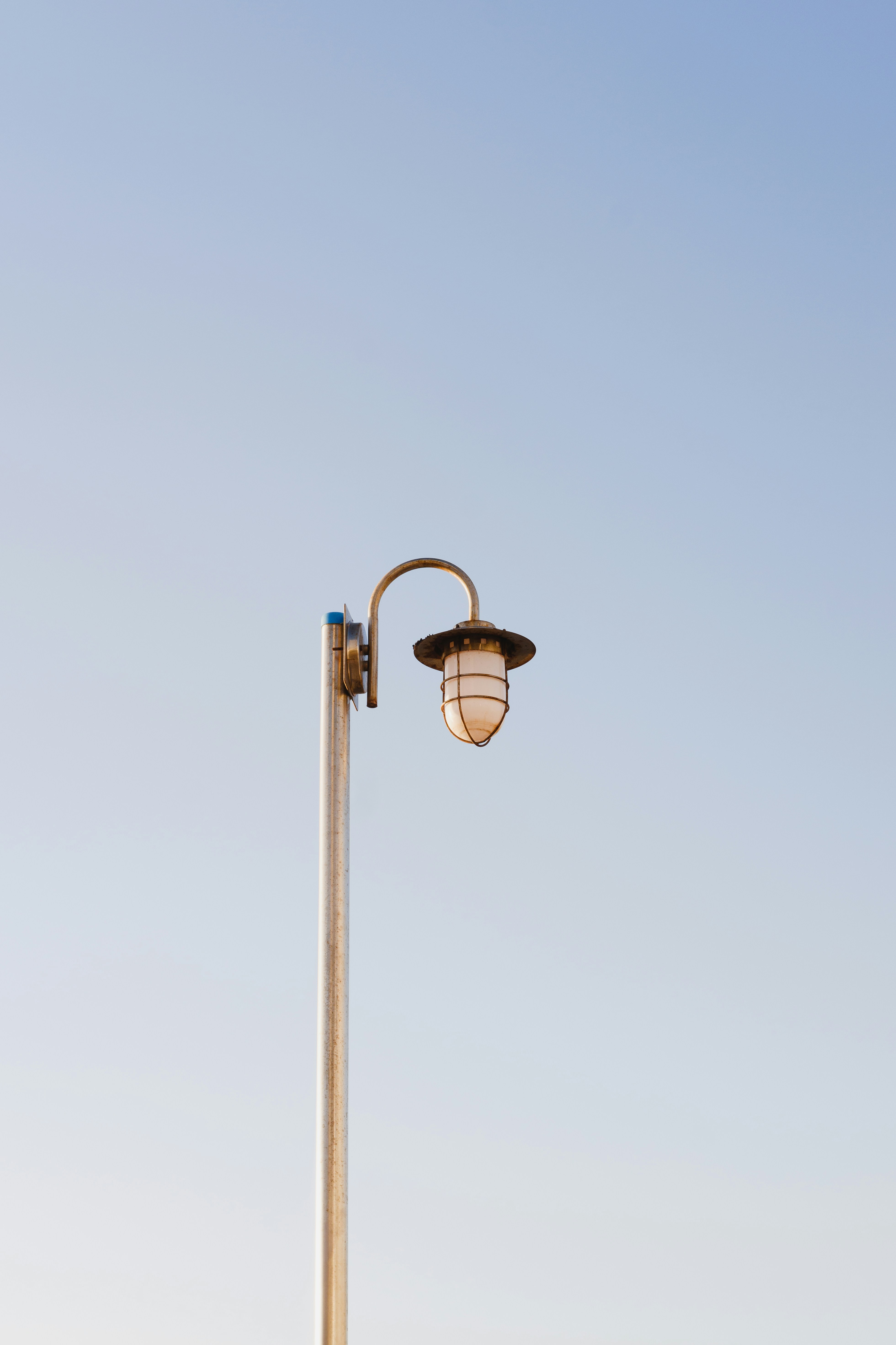 Lonely lamp post in Cape Town. | brown and white basketball hoop