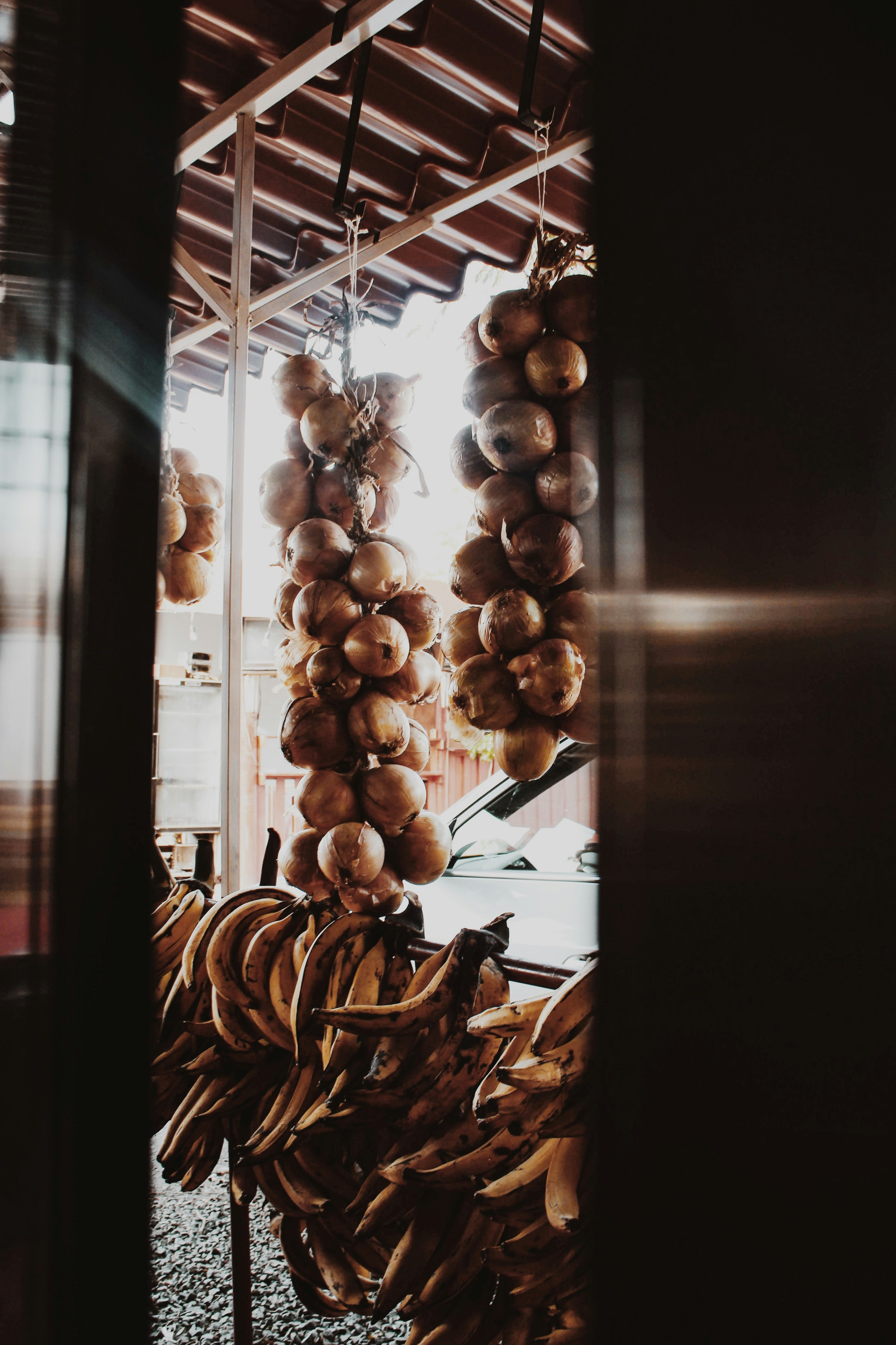 Hanging Bunches: Banana Stalls Framed Between Steel and Light