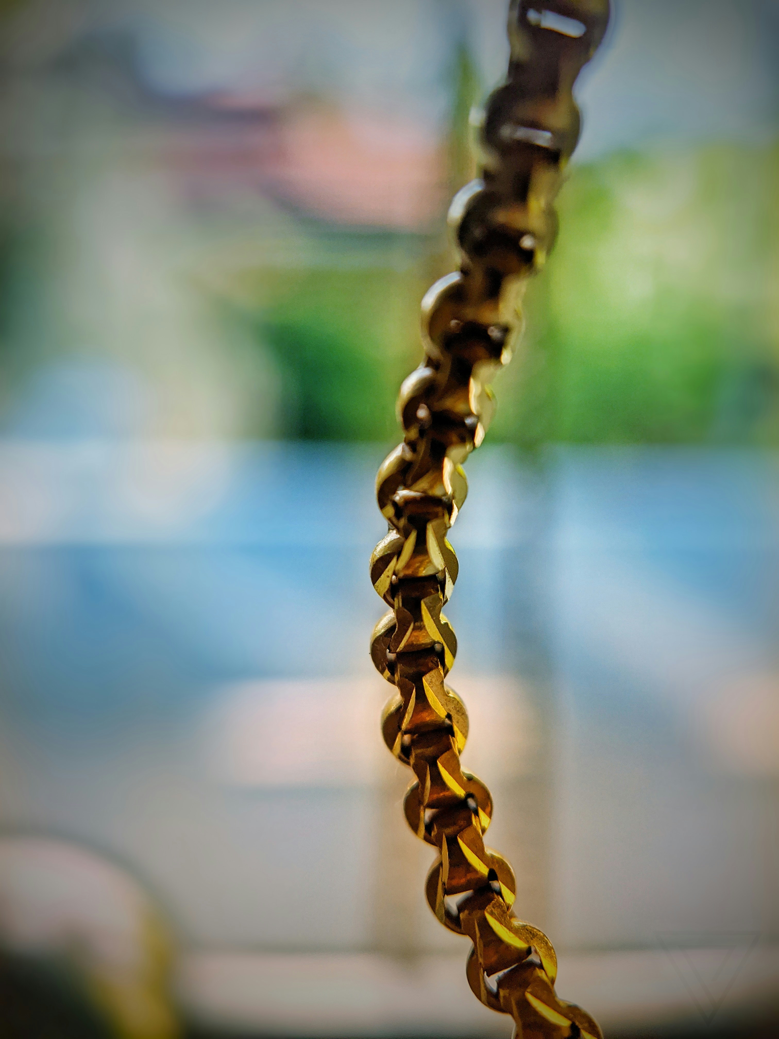 Macro shot of the Locks of a gold chain 
Taken on Pixel 3 using Moment Macro